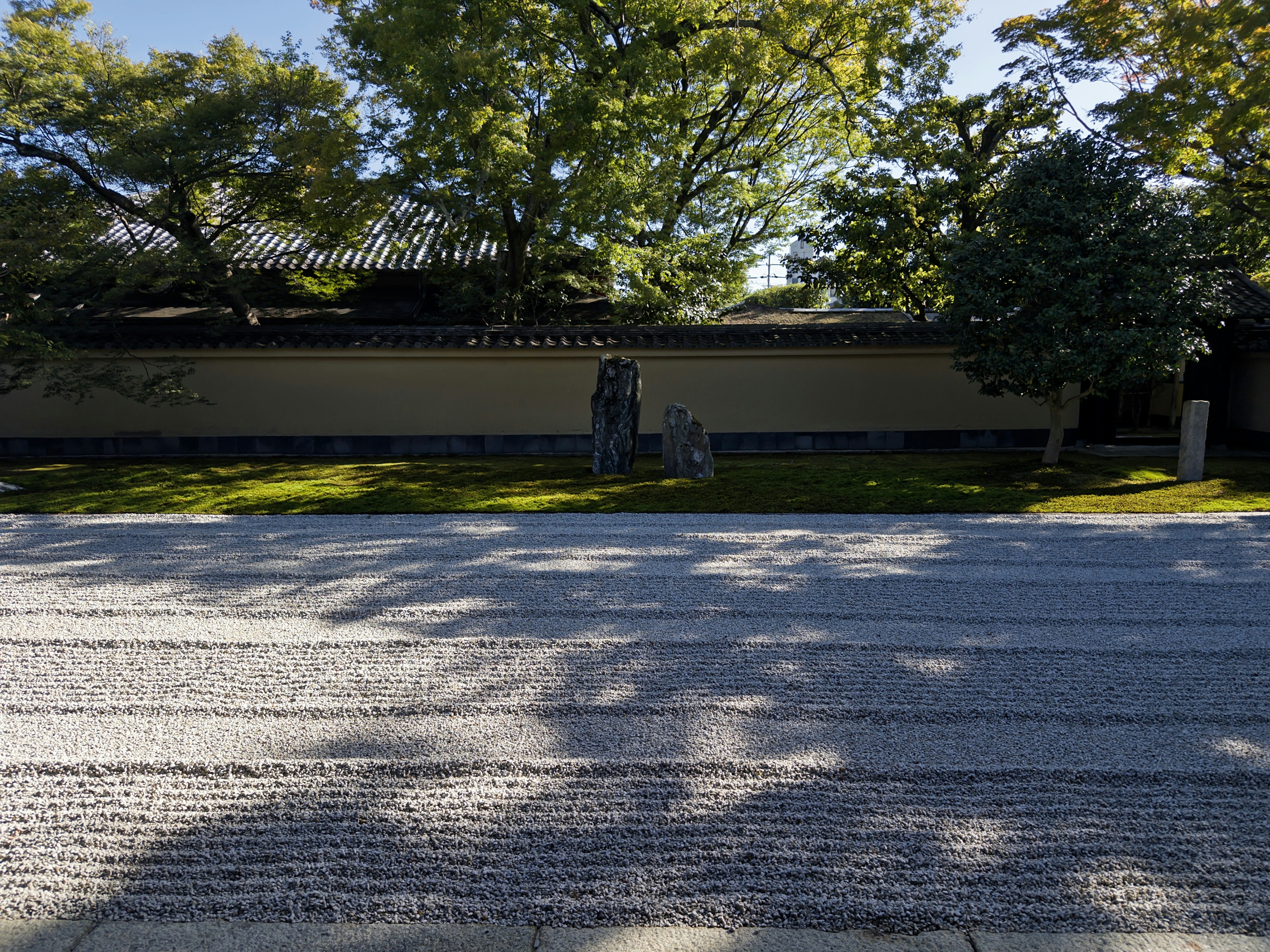 Raked Gravel and Quiet Wall under Dappled Shade