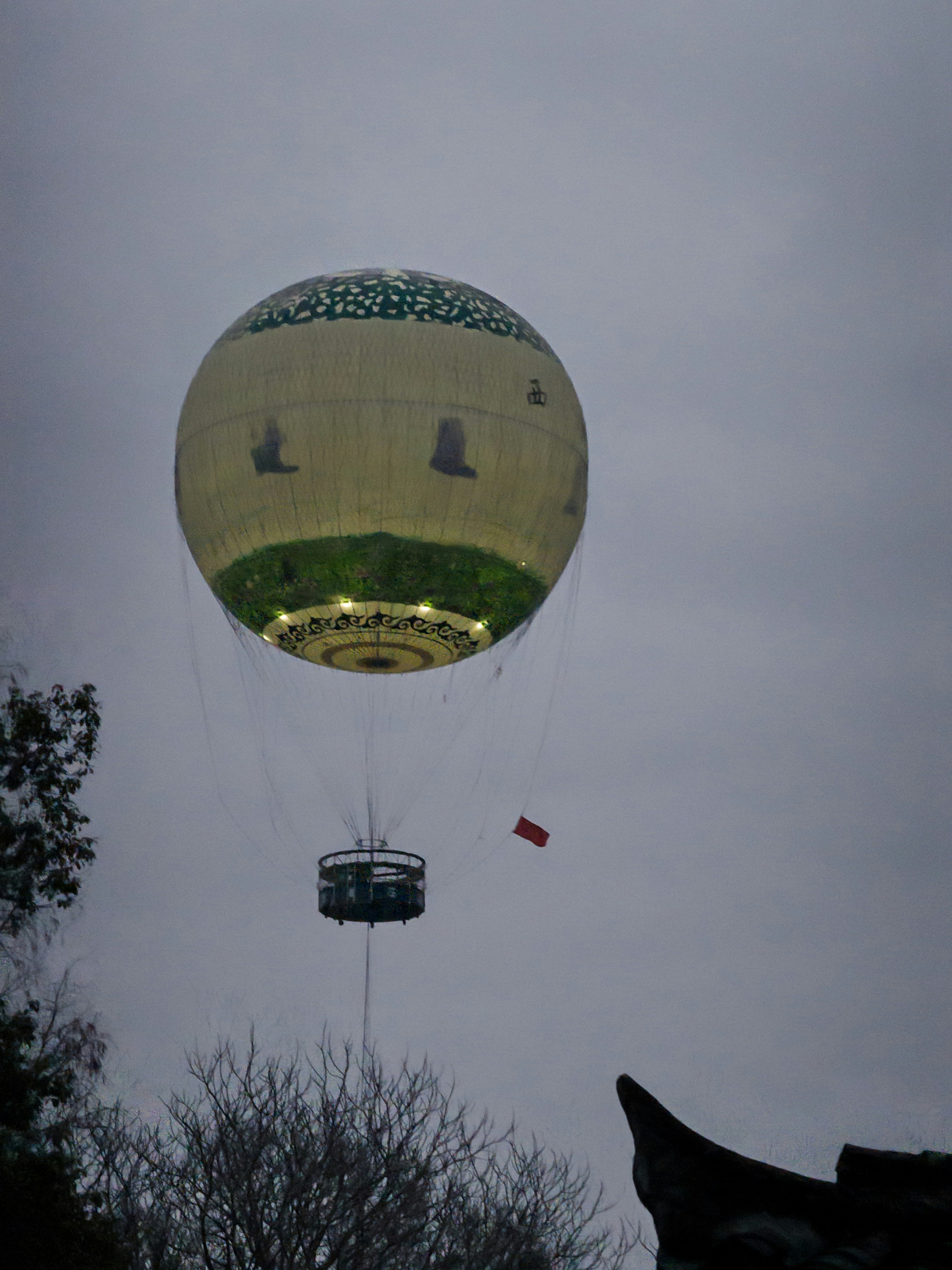 Balloon Ascent: A Pale Sky Carries a Lively Lantern