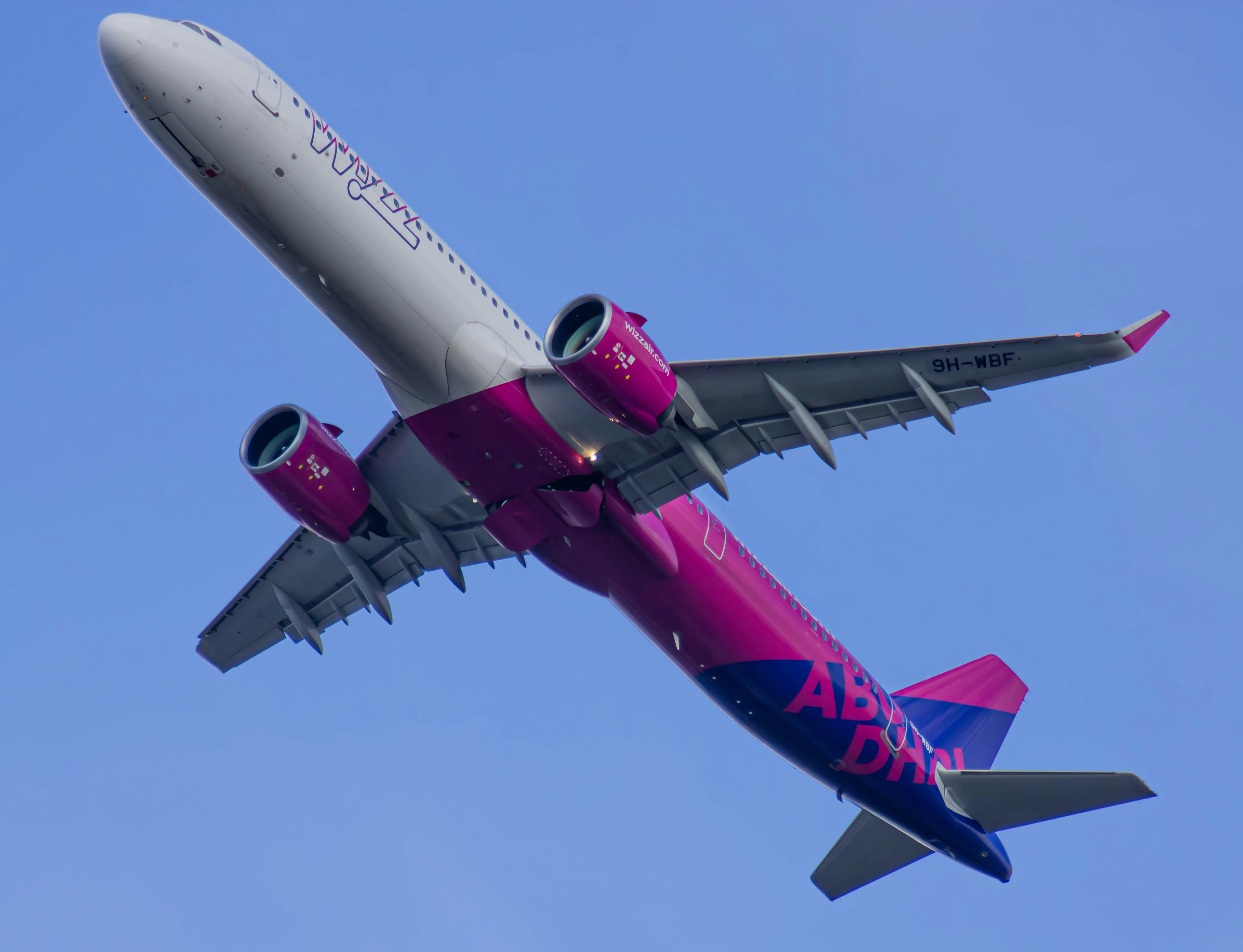 Vibrant Jet in Blue Sky: ABK Air a Burst of Magenta