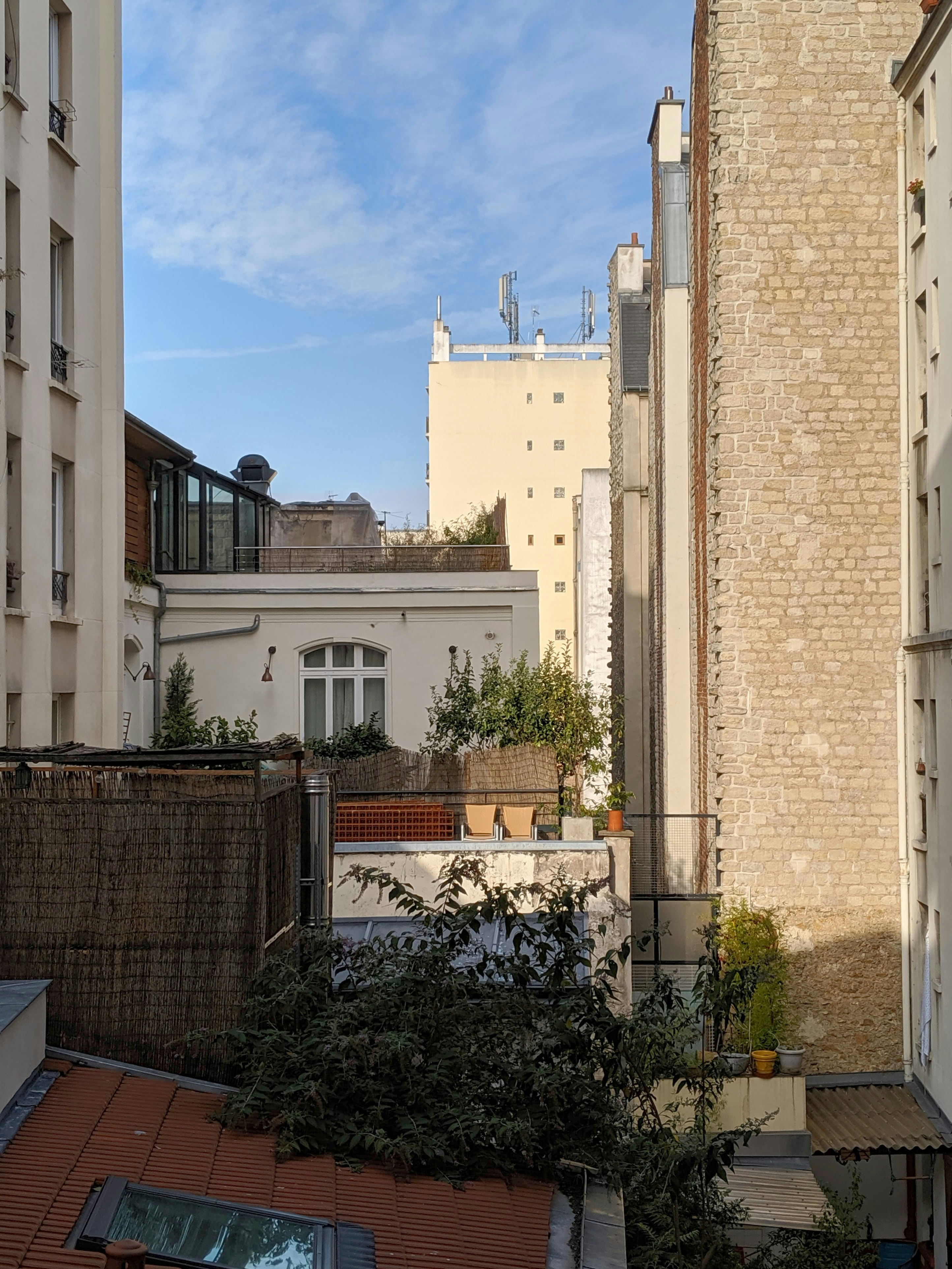 Urban Terrace Vista: Sunlit courtyard between stone and stucco