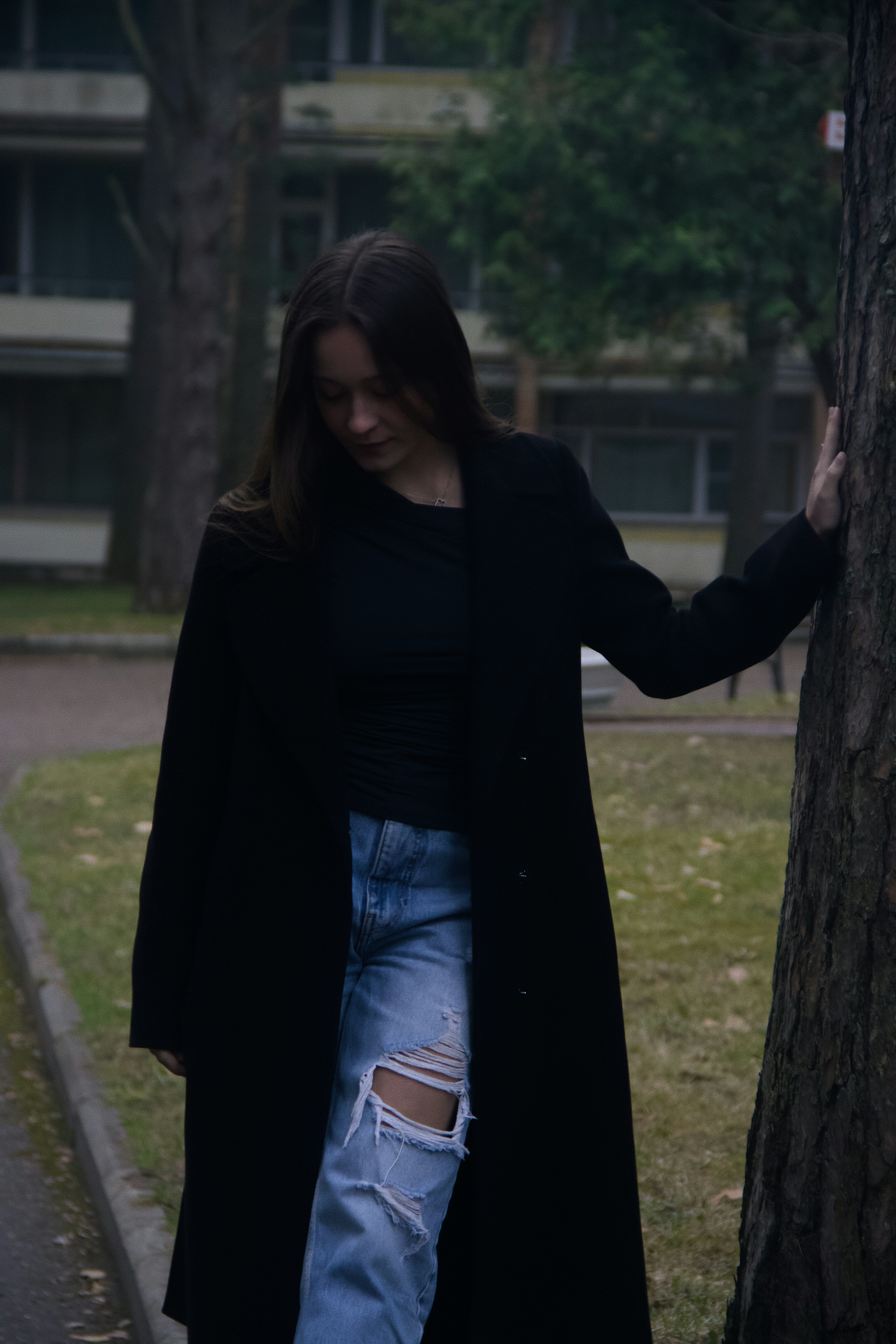 Midnight Palisade: A Woman in a Long Coat by the Trees