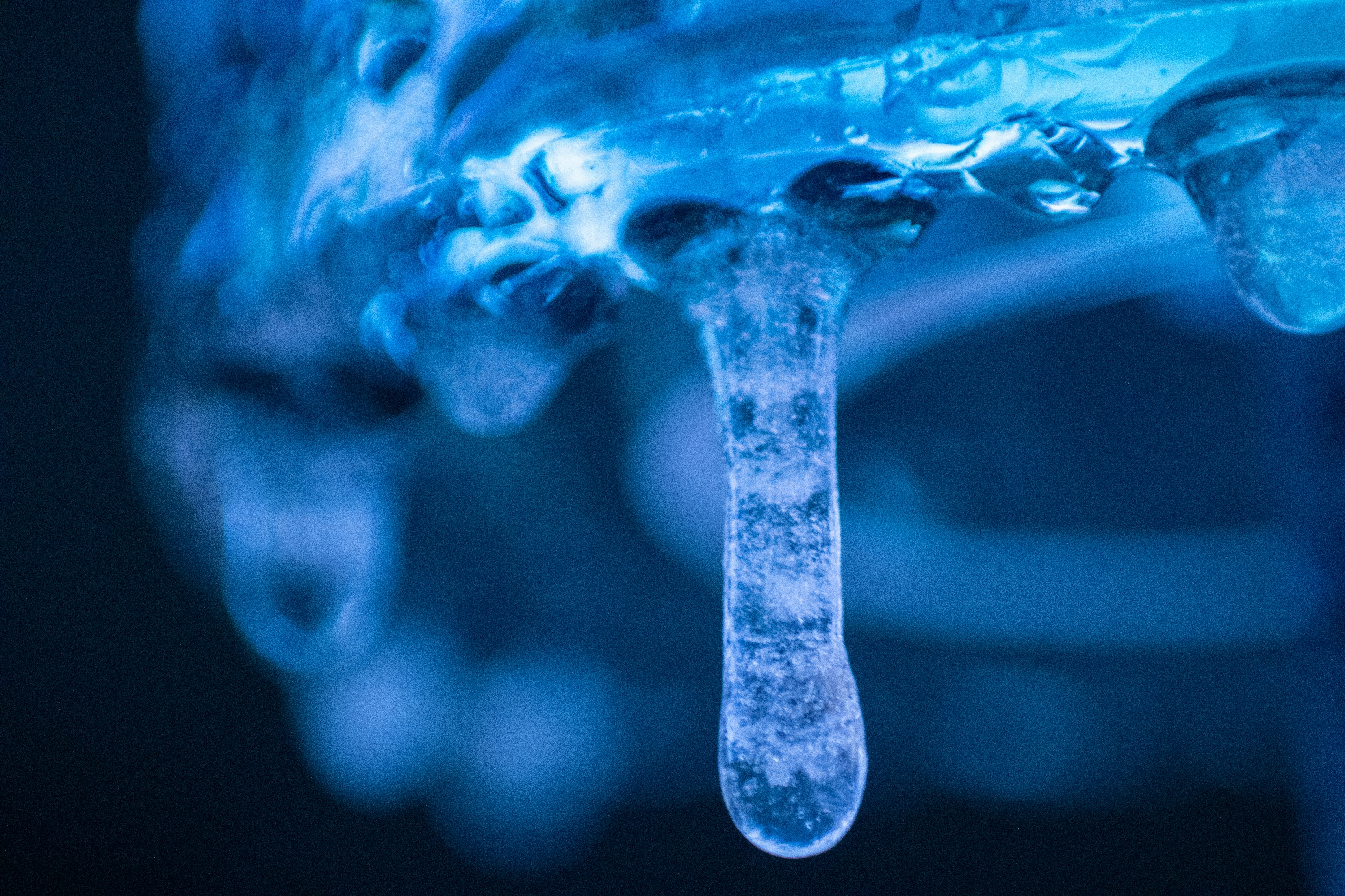 Icicle formed on a vintage early 1900’s blue glass electrical insulator