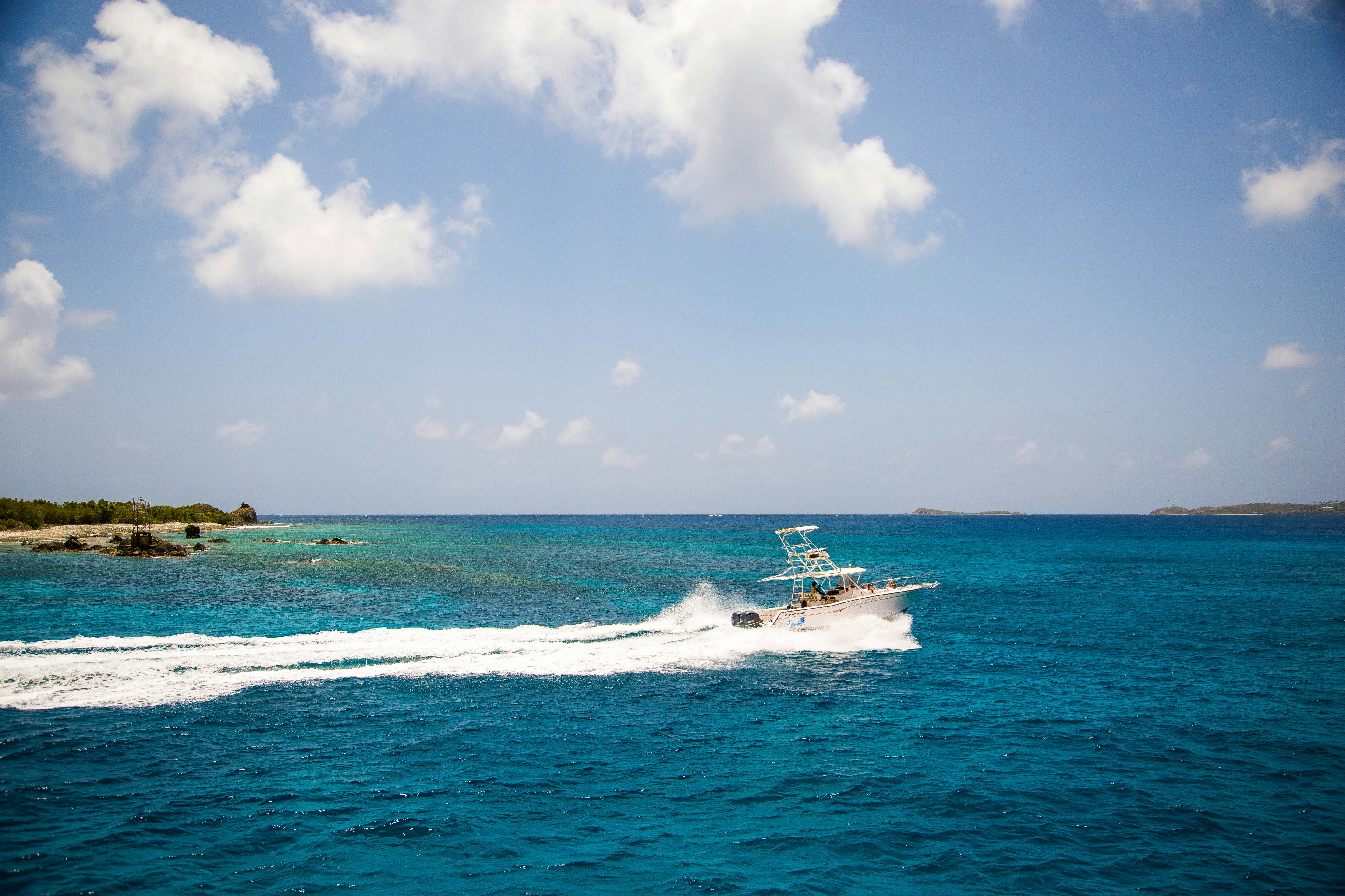 Azure Wake: A Speedboat Carves a White Ribbon Across Turquoise Seas