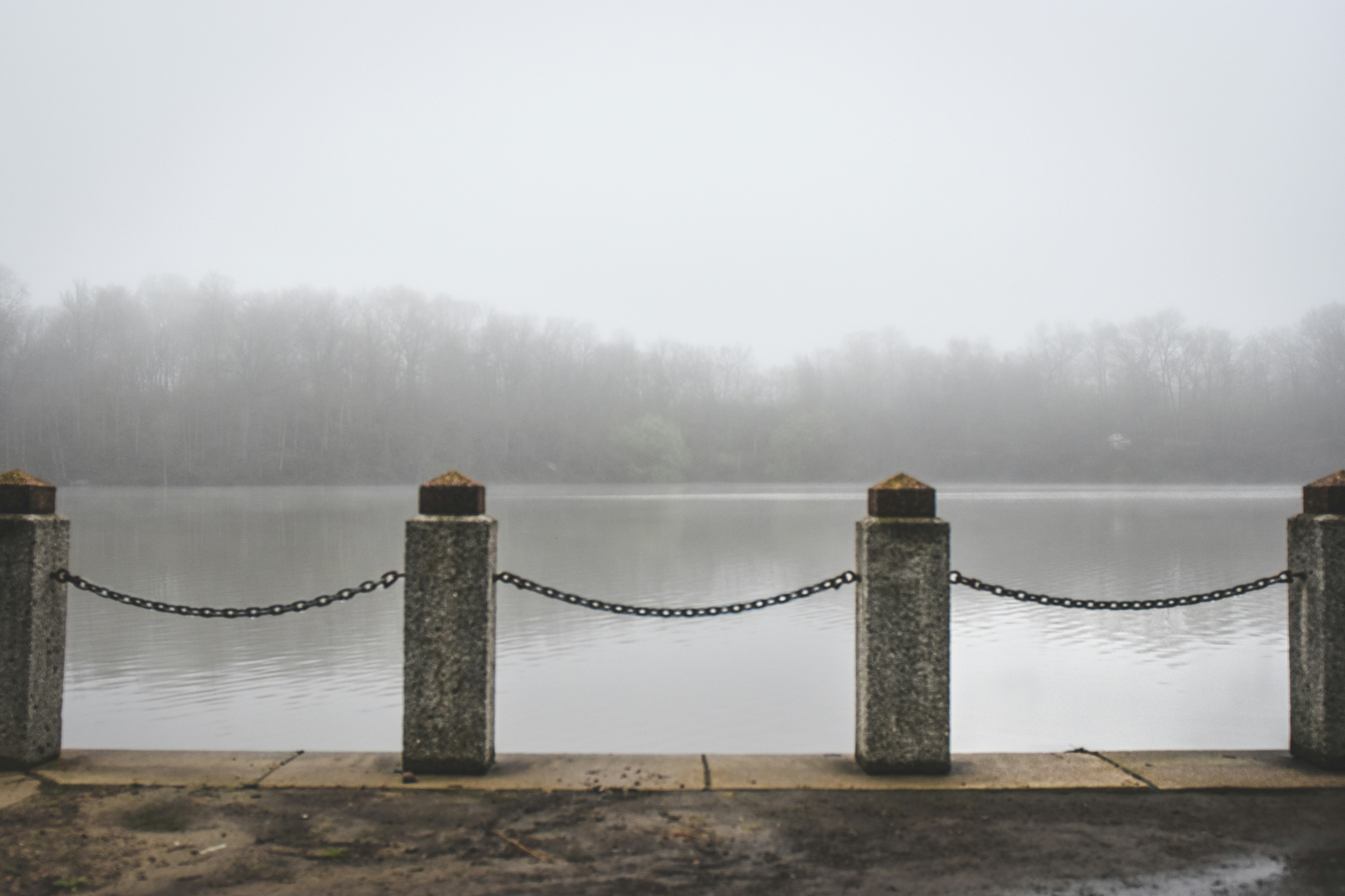 Misty Pier: Chains and Calm on a Quiet Lake