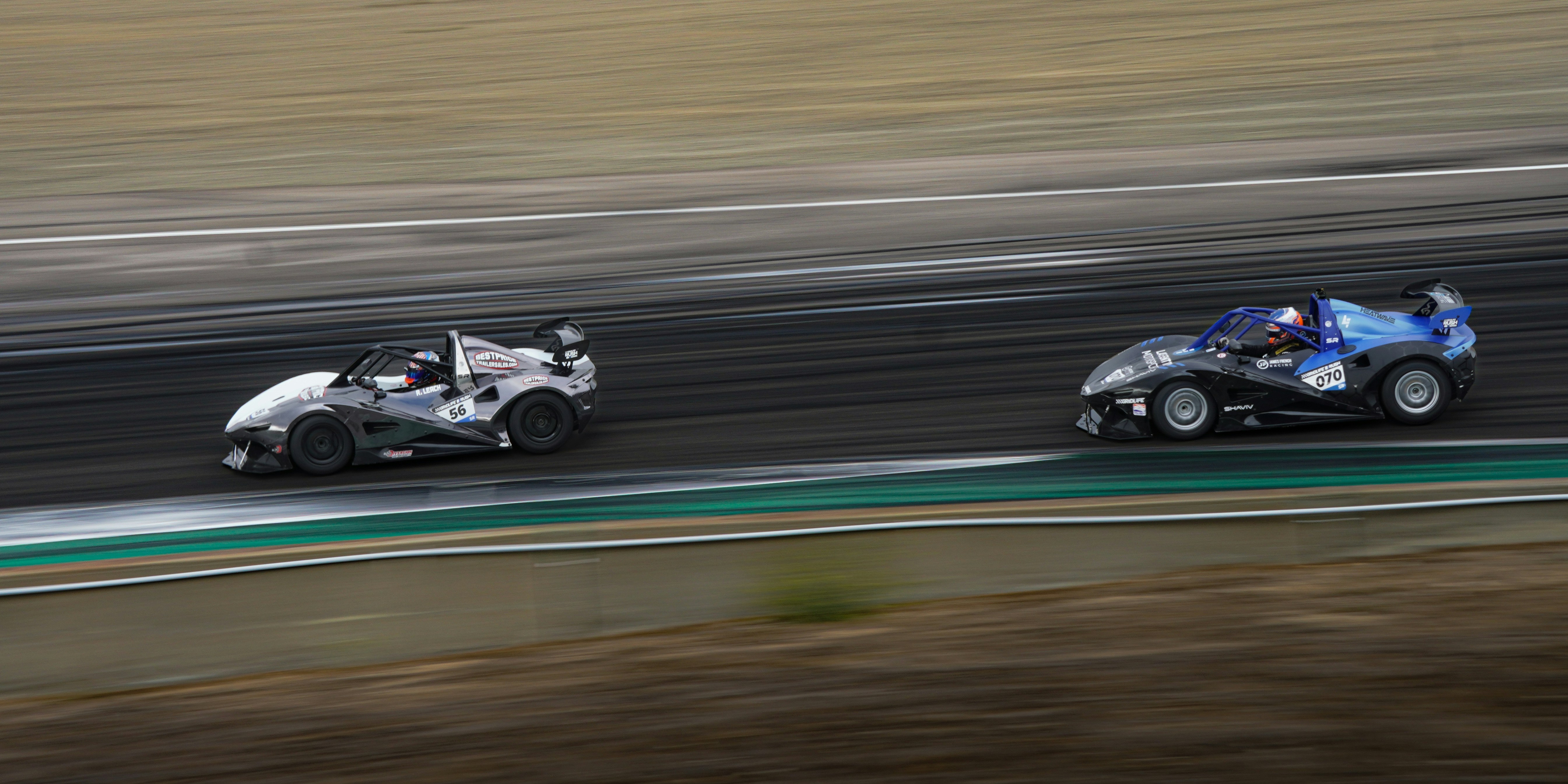 Twin-Speed Duel: Silver and Blue Prototypes Blazing on a Race Strip