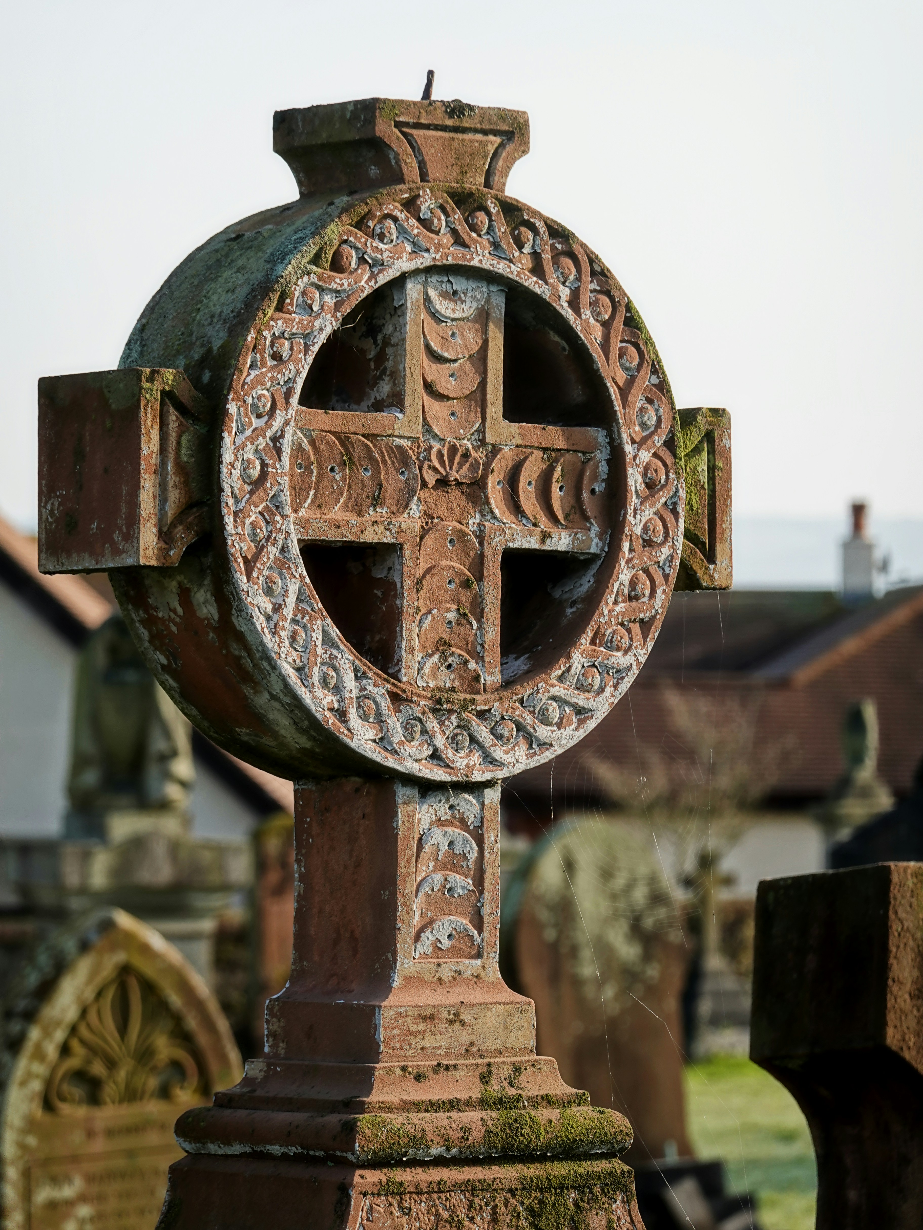 Ancient Iron Cross Monument Rising from a Mossy Pedestal