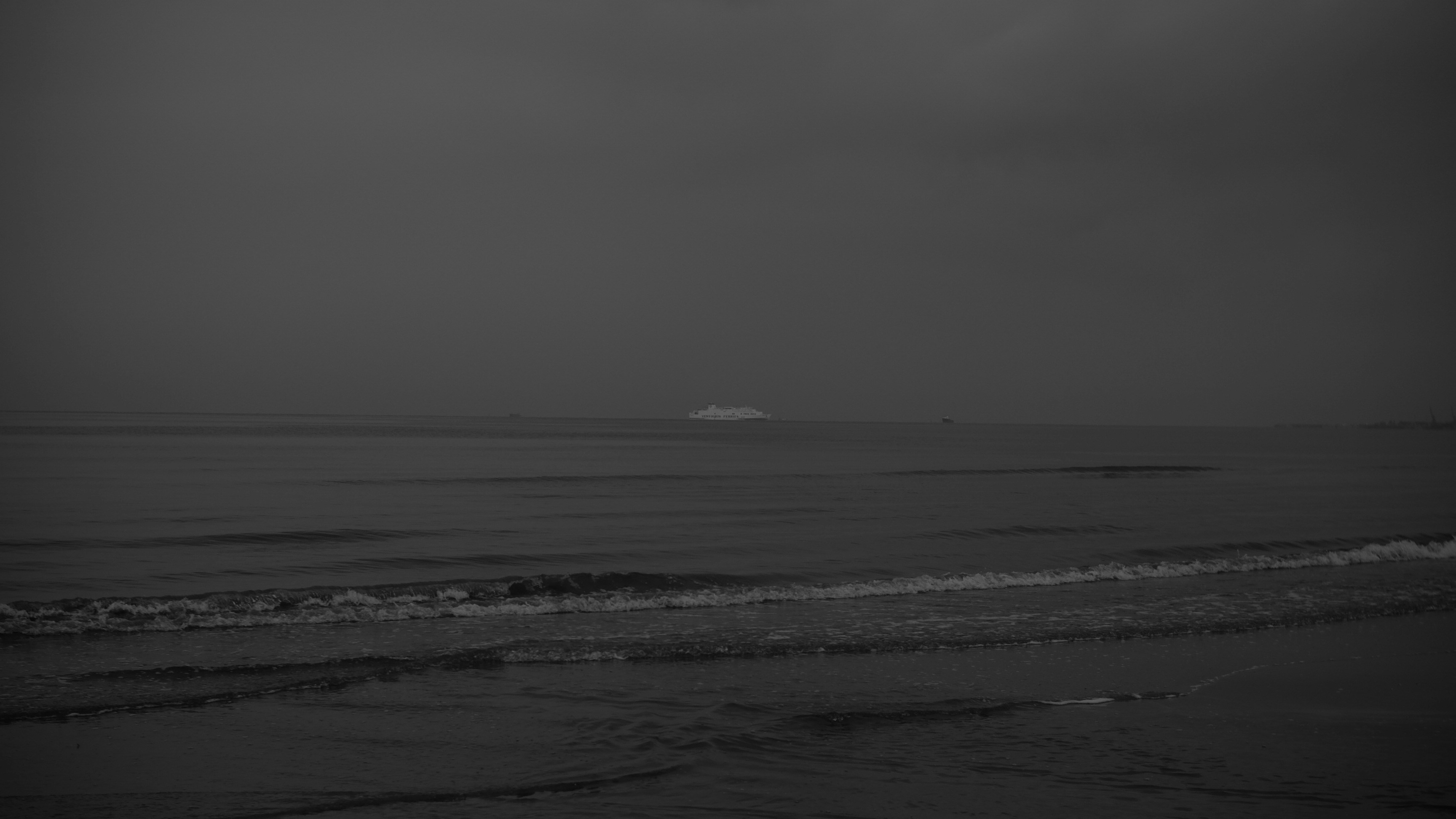 Muted Horizon, Quiet Shore: A Monochrome Sea at Dusk
