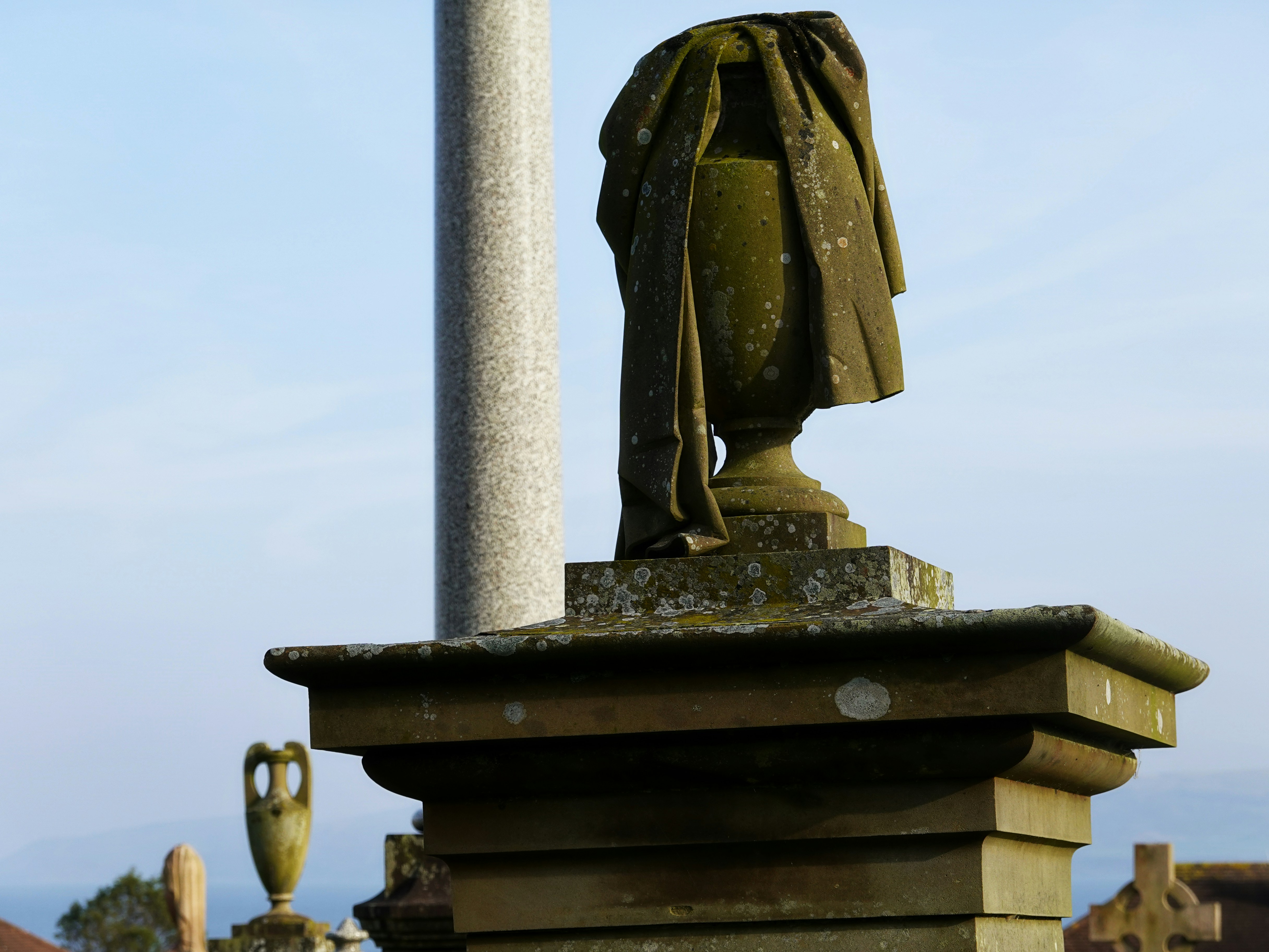 Weathered pedestal, veiled by rain or moss