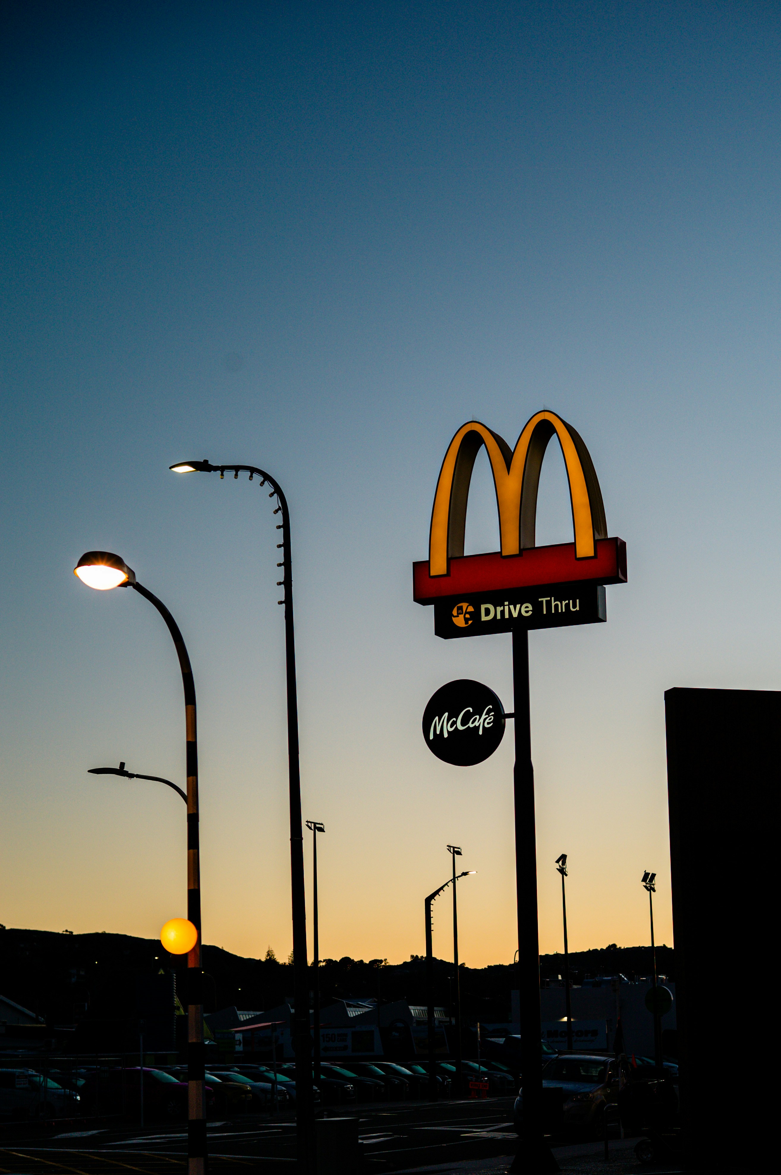 Golden Arches at Dusk: McDonald's Drive Thru Sign Silhouette