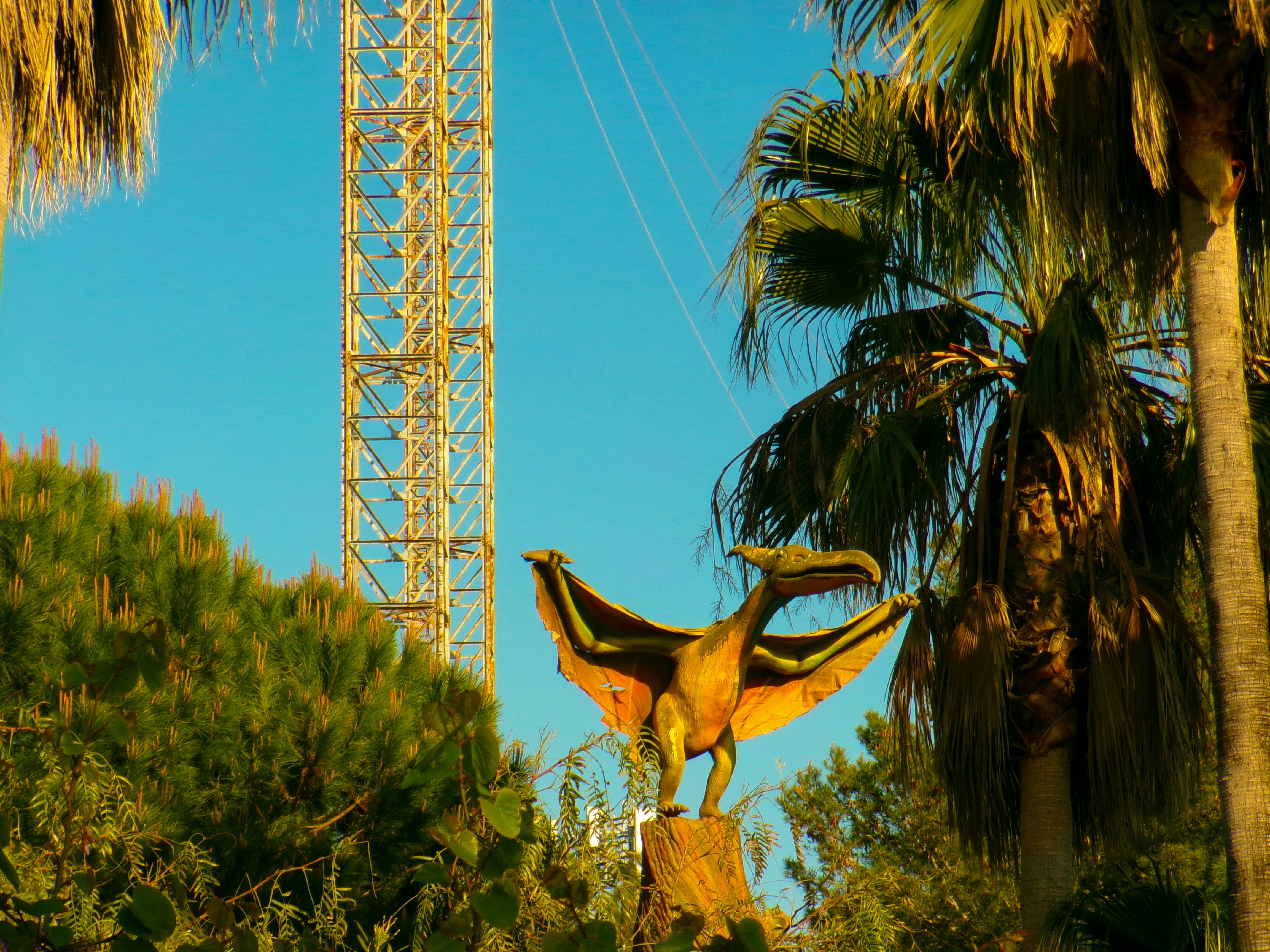 Dinosaur Spur of Dusk: A Sculpture Reaches Toward the Palm Canopy