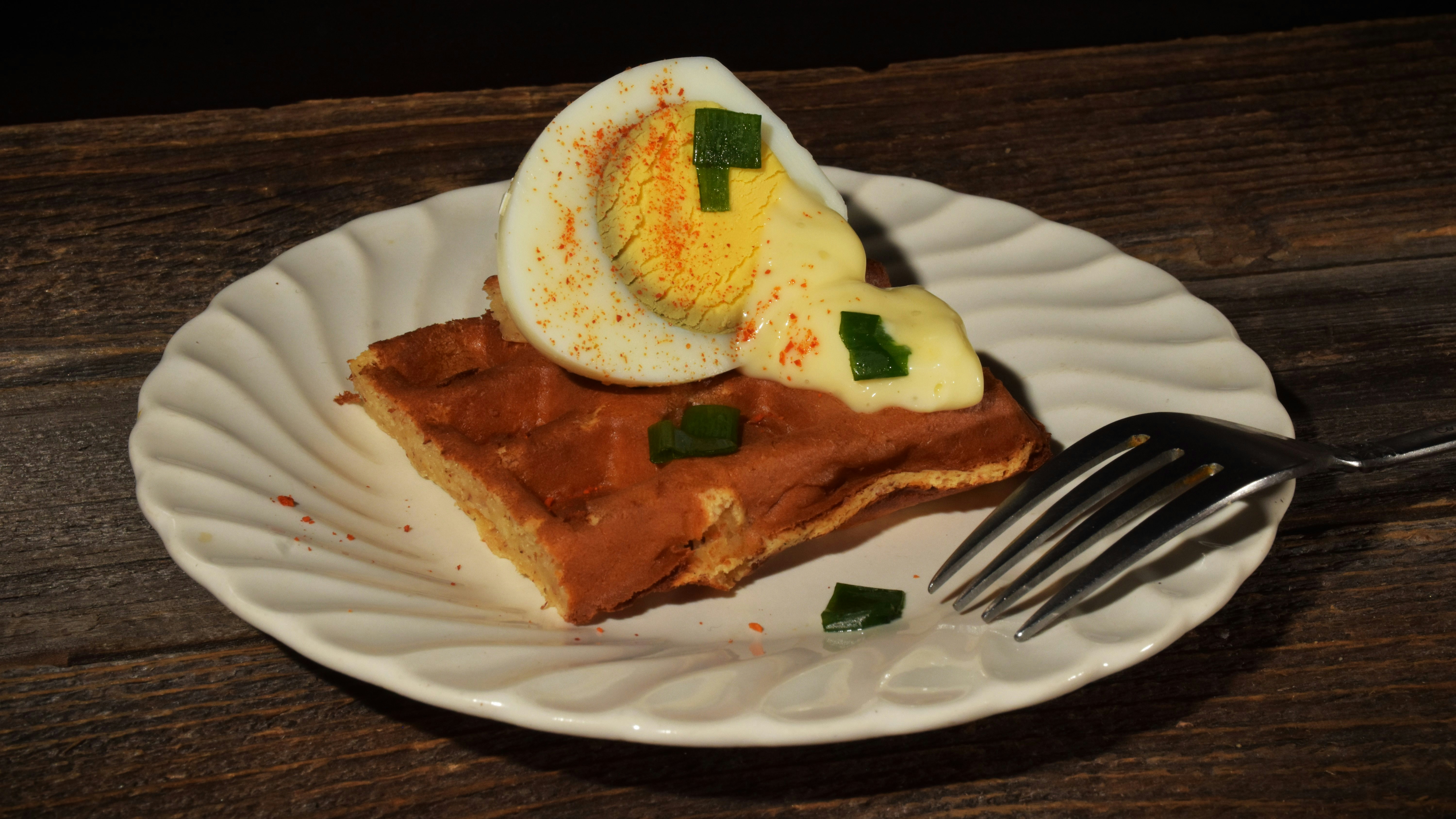 Chewy Slice with Creamy Topping and Garnish on a White Plate