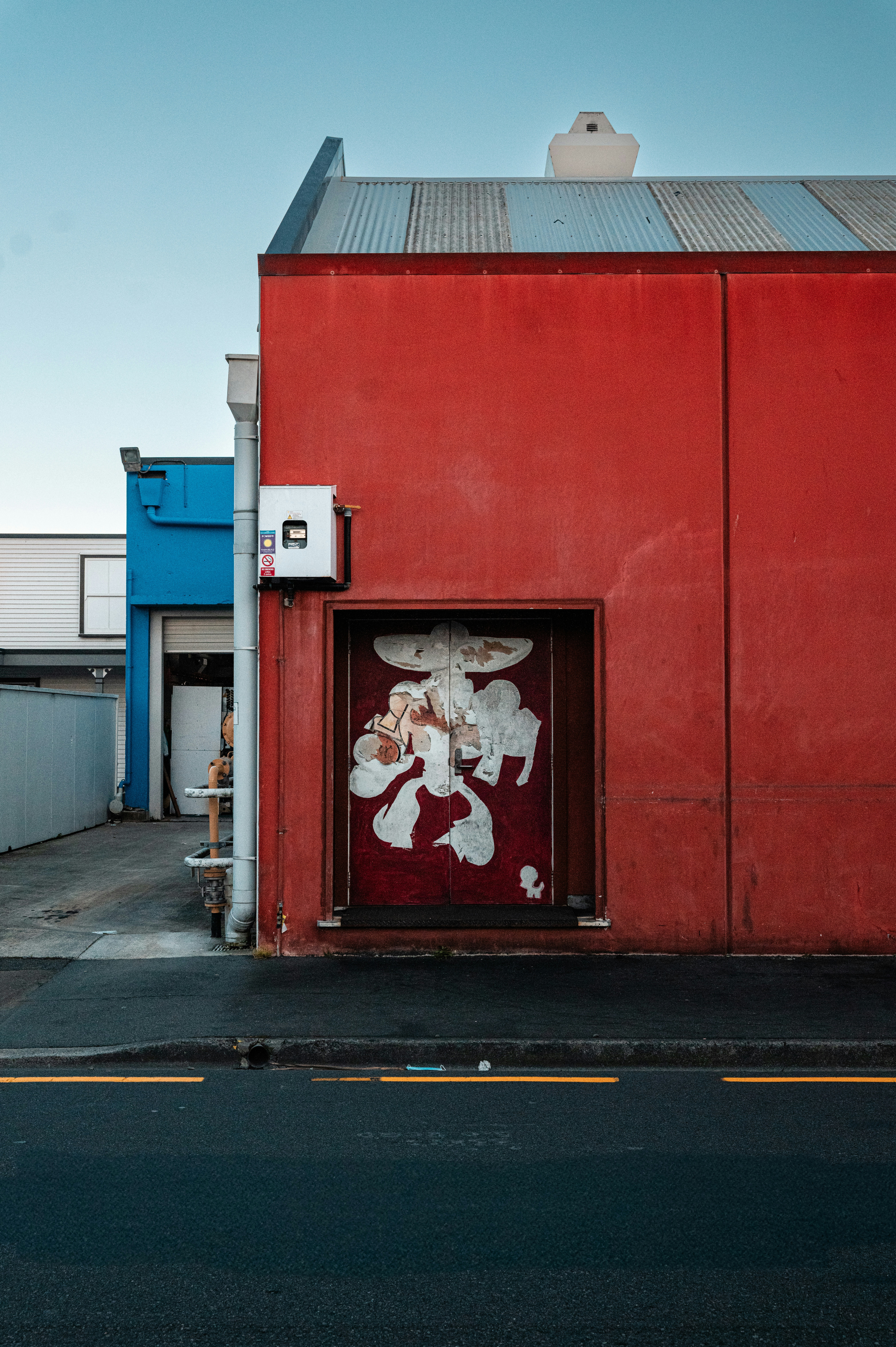 Red Wall Gallery: A Doorway of Quiet Murals