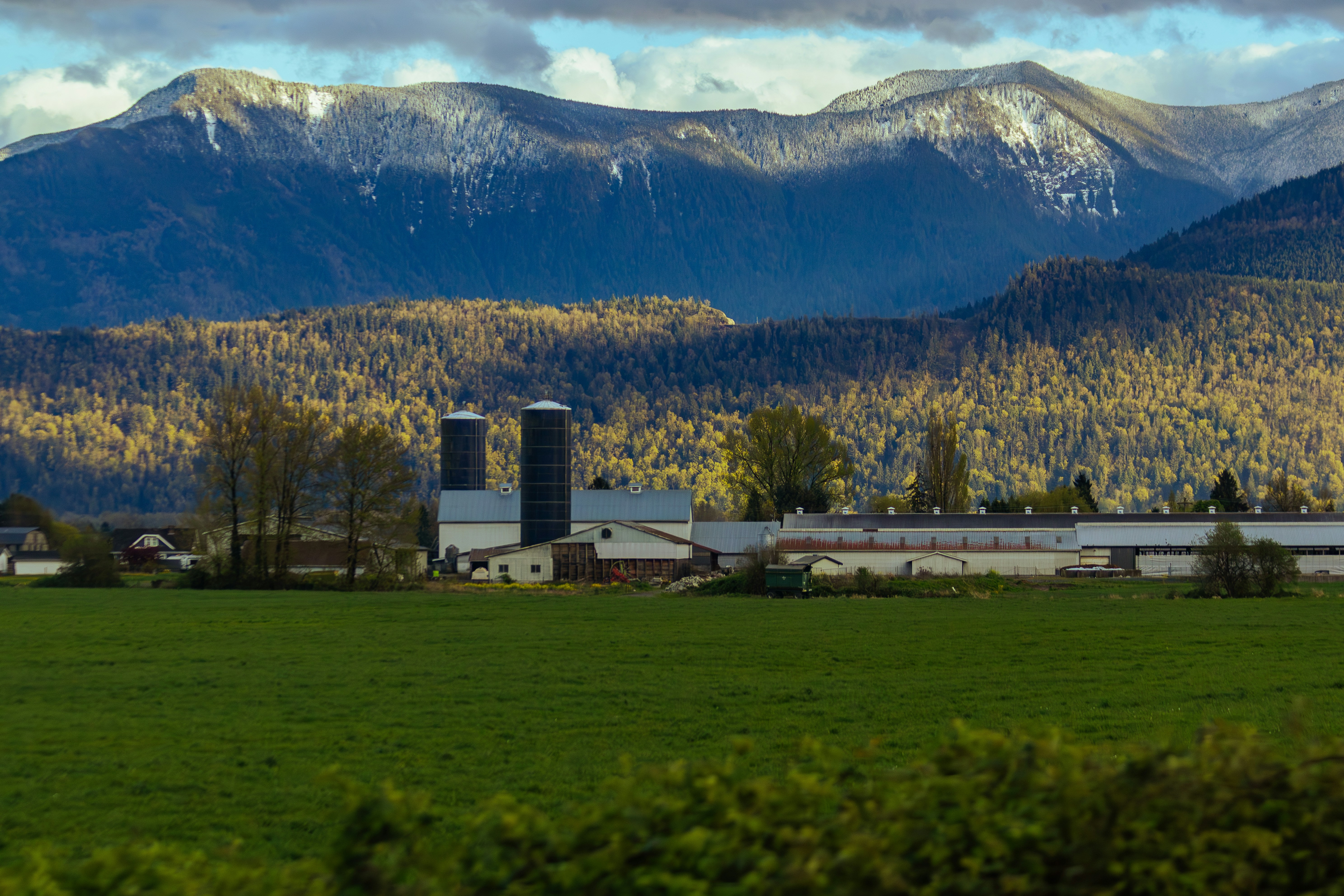 Barns at the Foot of a Rolling Mountain Range