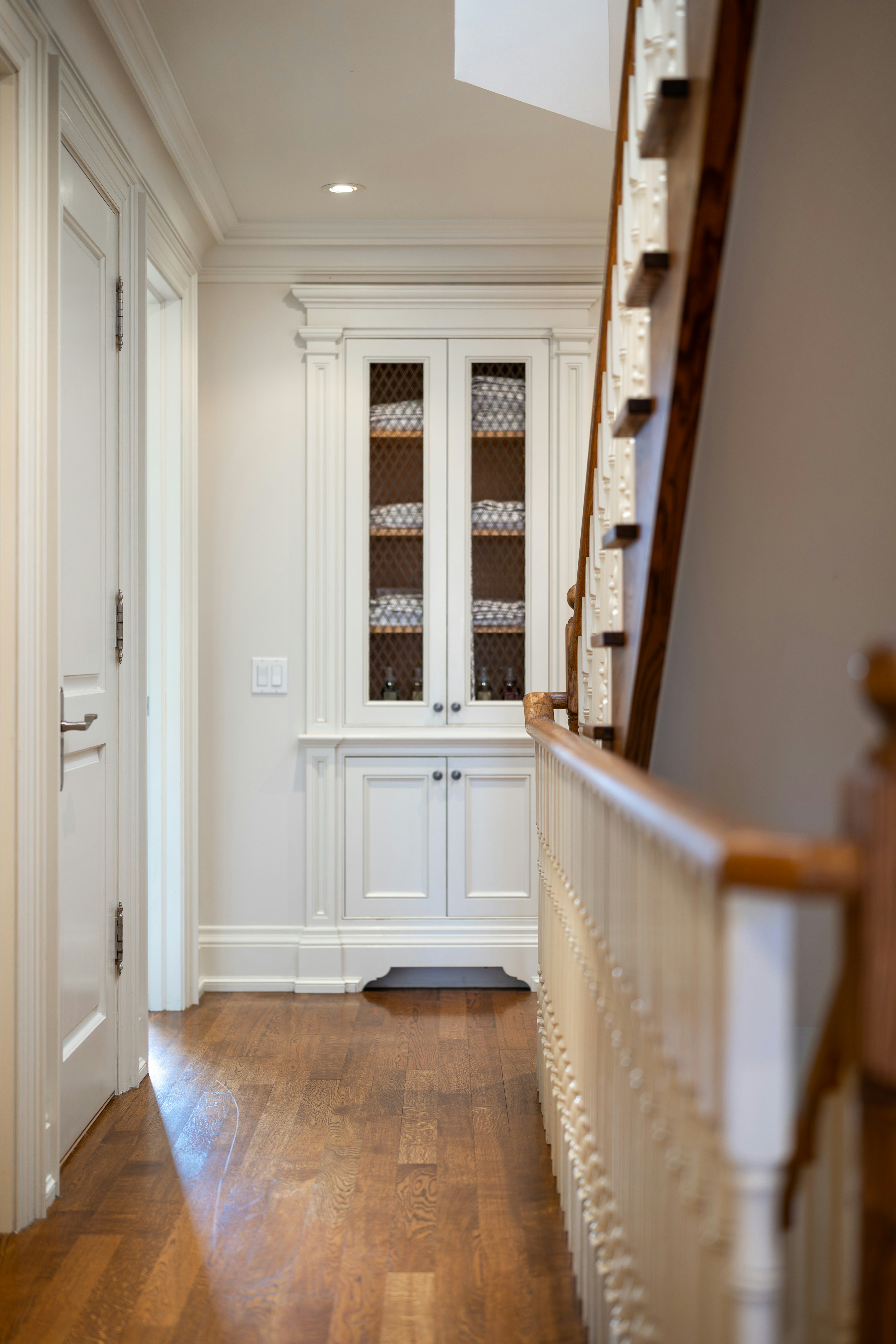 Hallway Cabinetry and Staircase: A Quiet Corridor of White Woodwork