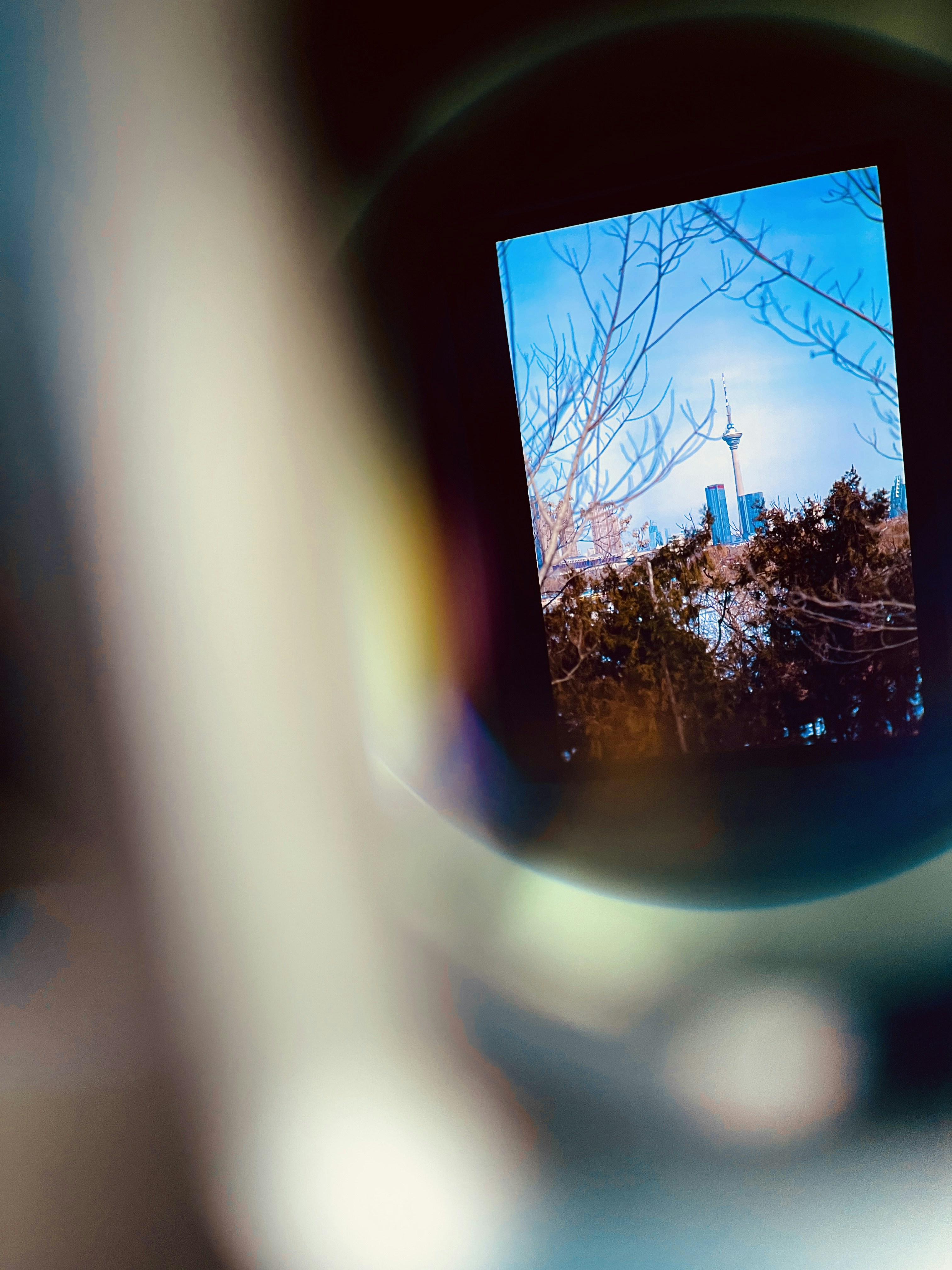Reflections in a Lens: skyline glimpsed through a blurred aperture