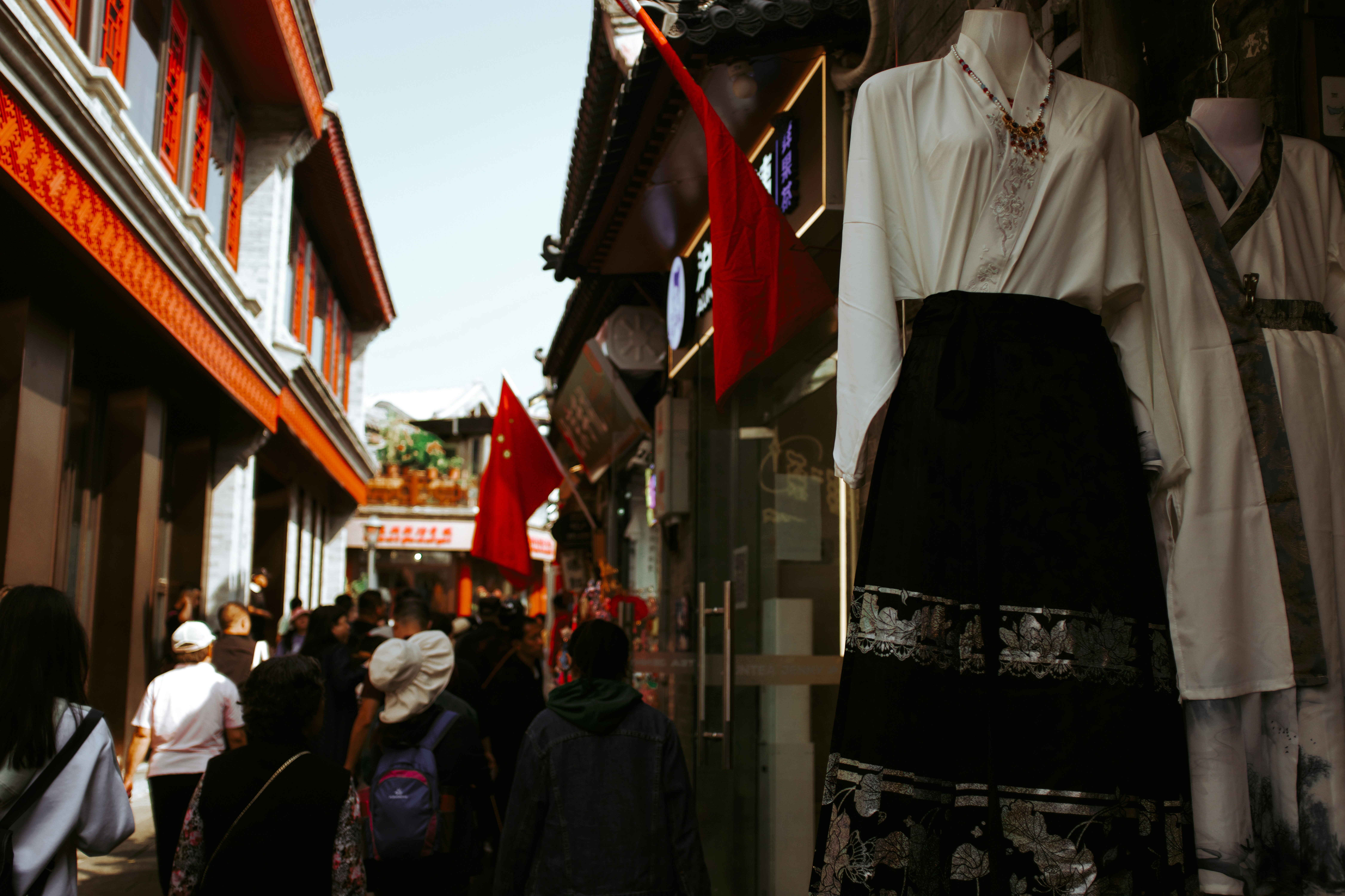Shopfronts and Red Flags: A Narrow Street in Motion
