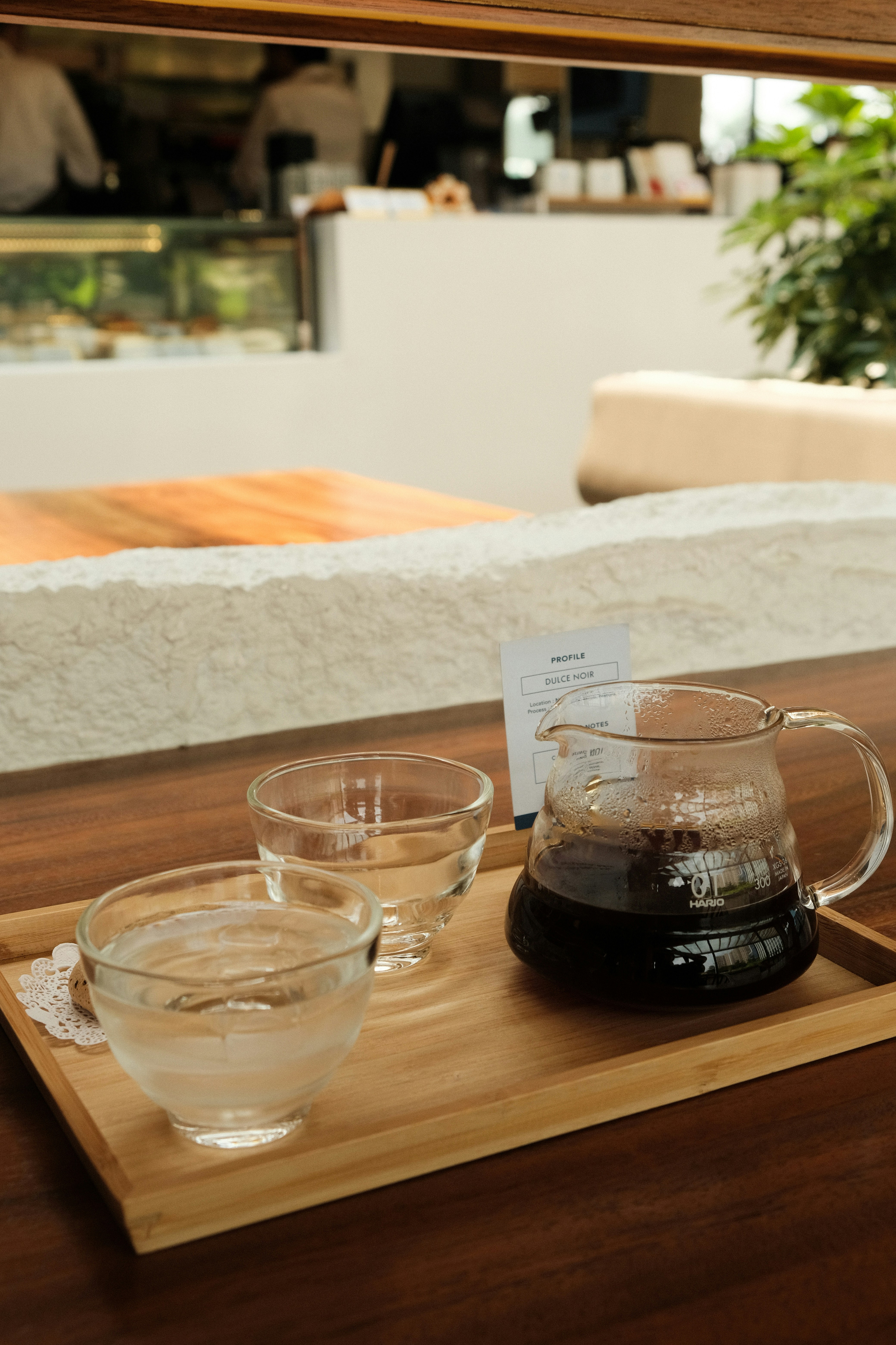 Tray of Brewed Quiet: A Café Scene with Glassware and Carafe