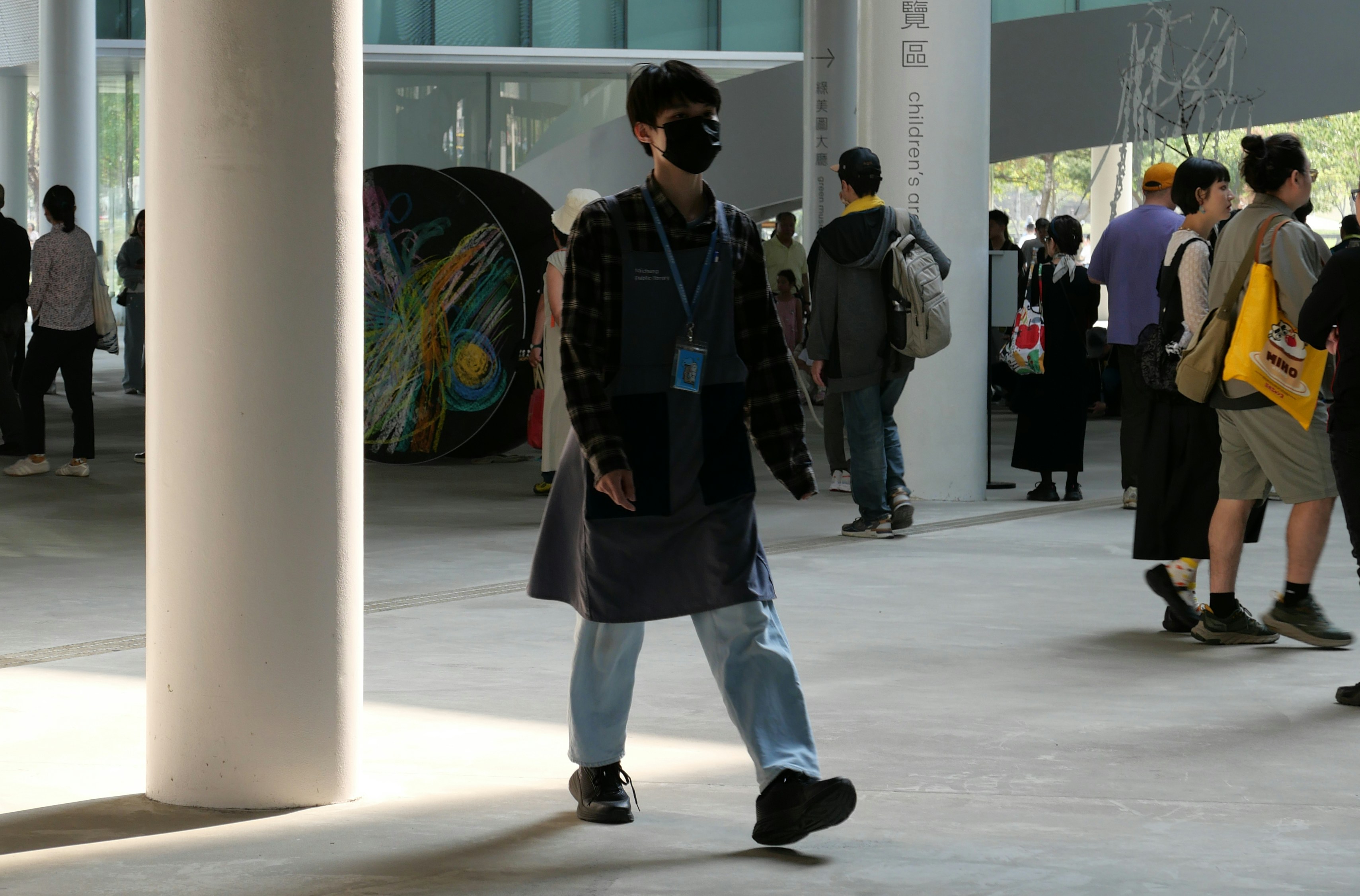 Masked Pedestrian in a Modern Corridor