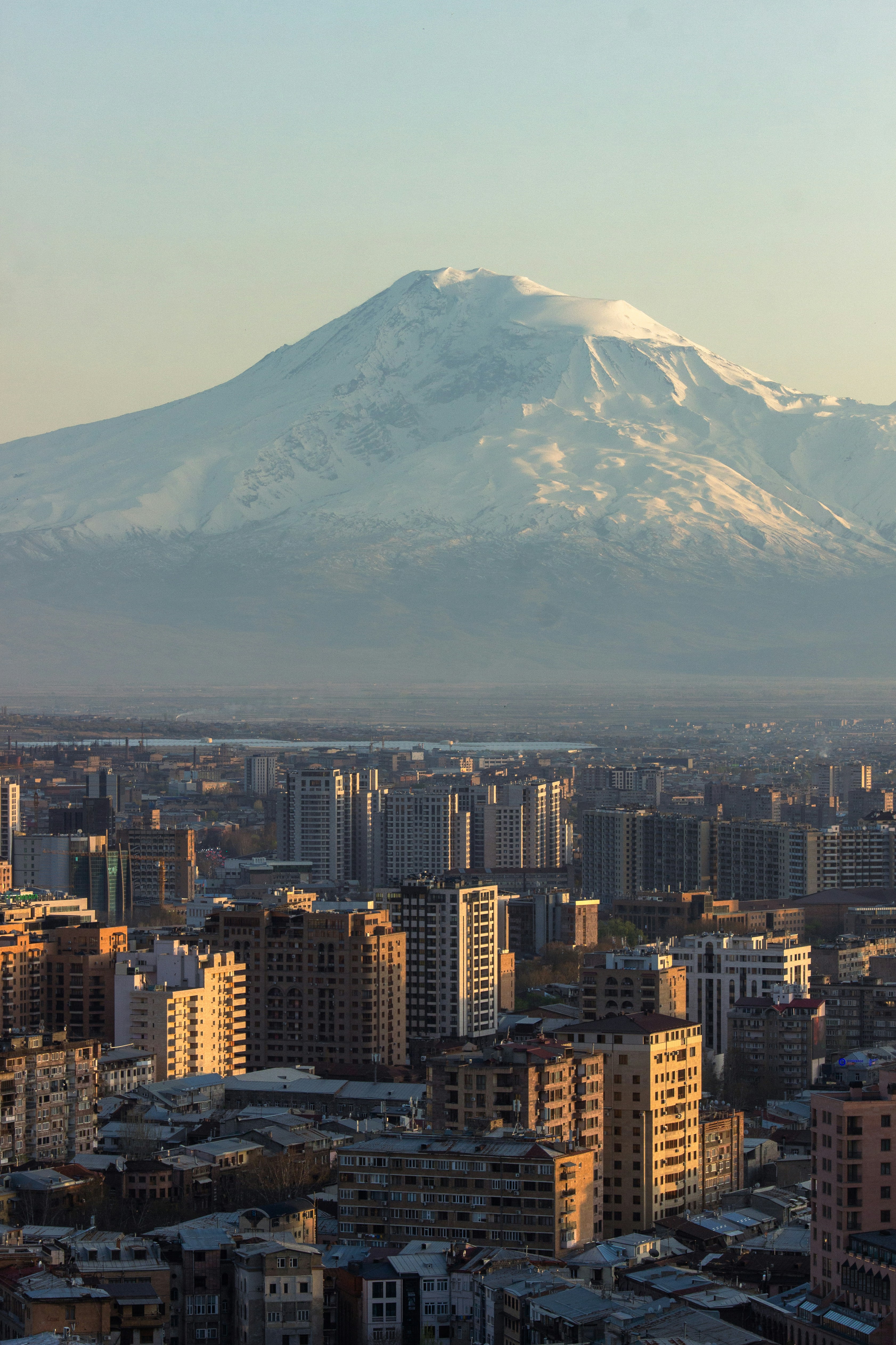 Snowbound Peak Over a Metal City