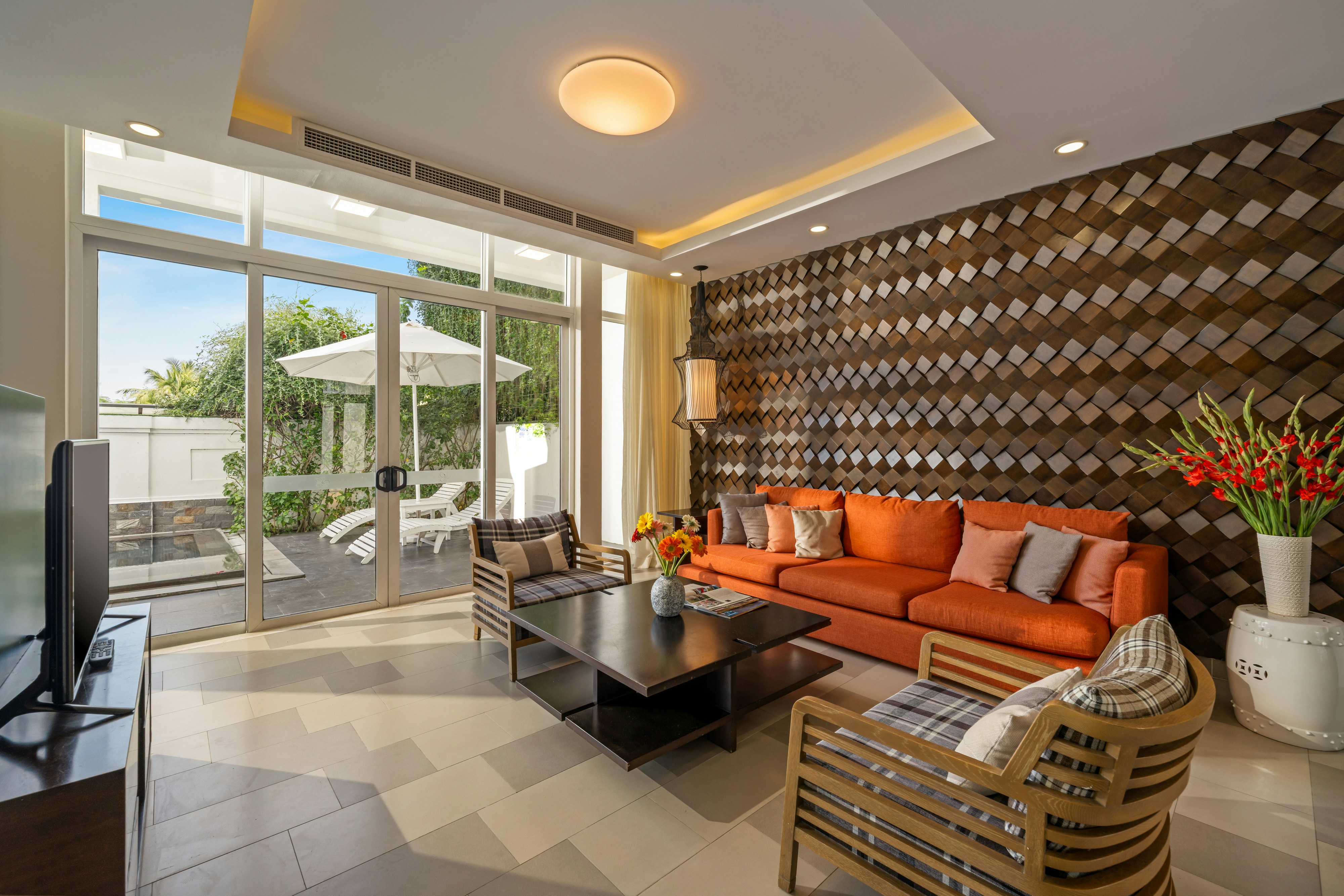 Sunlit Modern Lounge with Geometric Accent Wall and Outdoor Patio