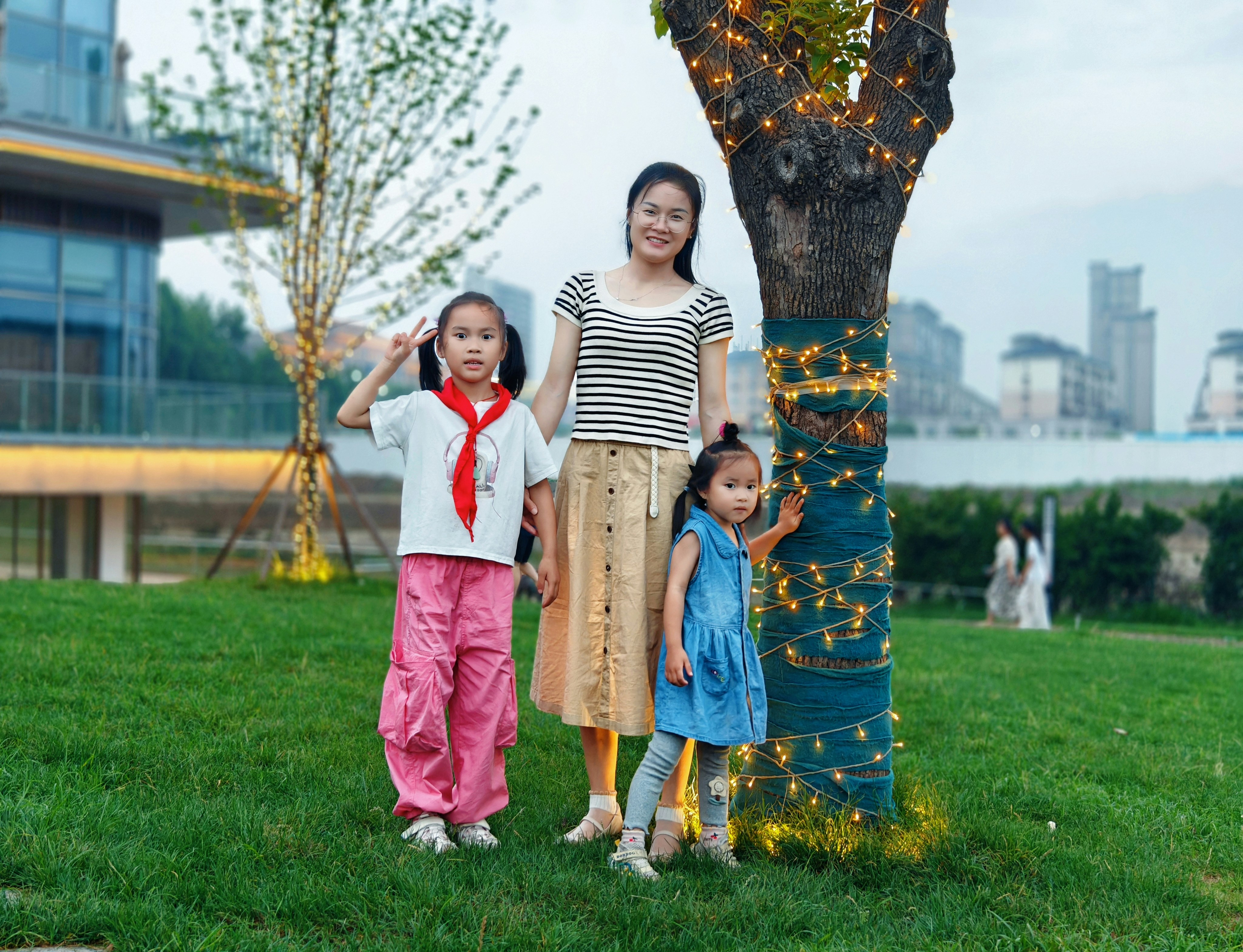 Family by the Tree Lights: Evening Portrait in a Park