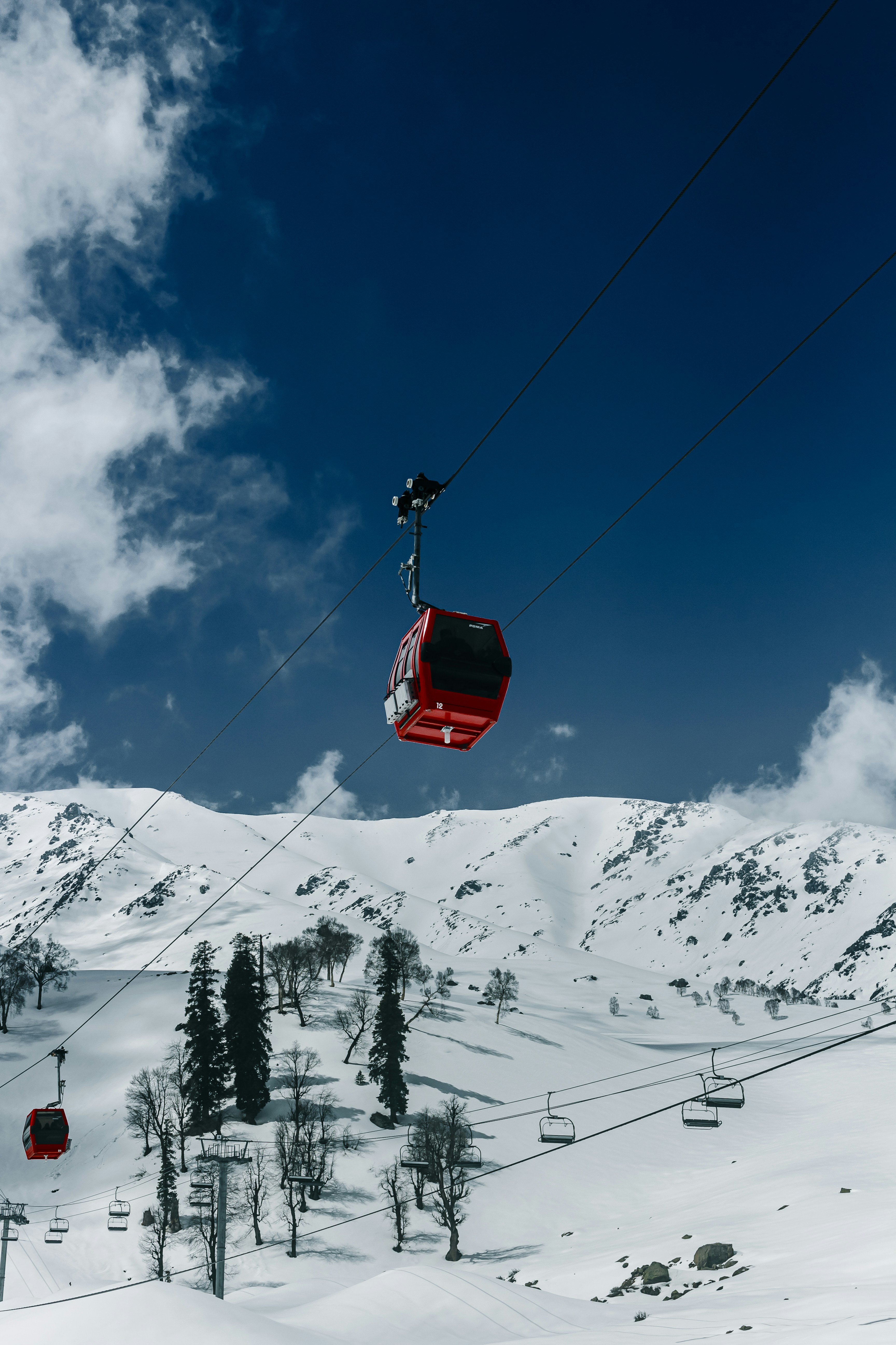 Red Gondola Above Icy Ridge