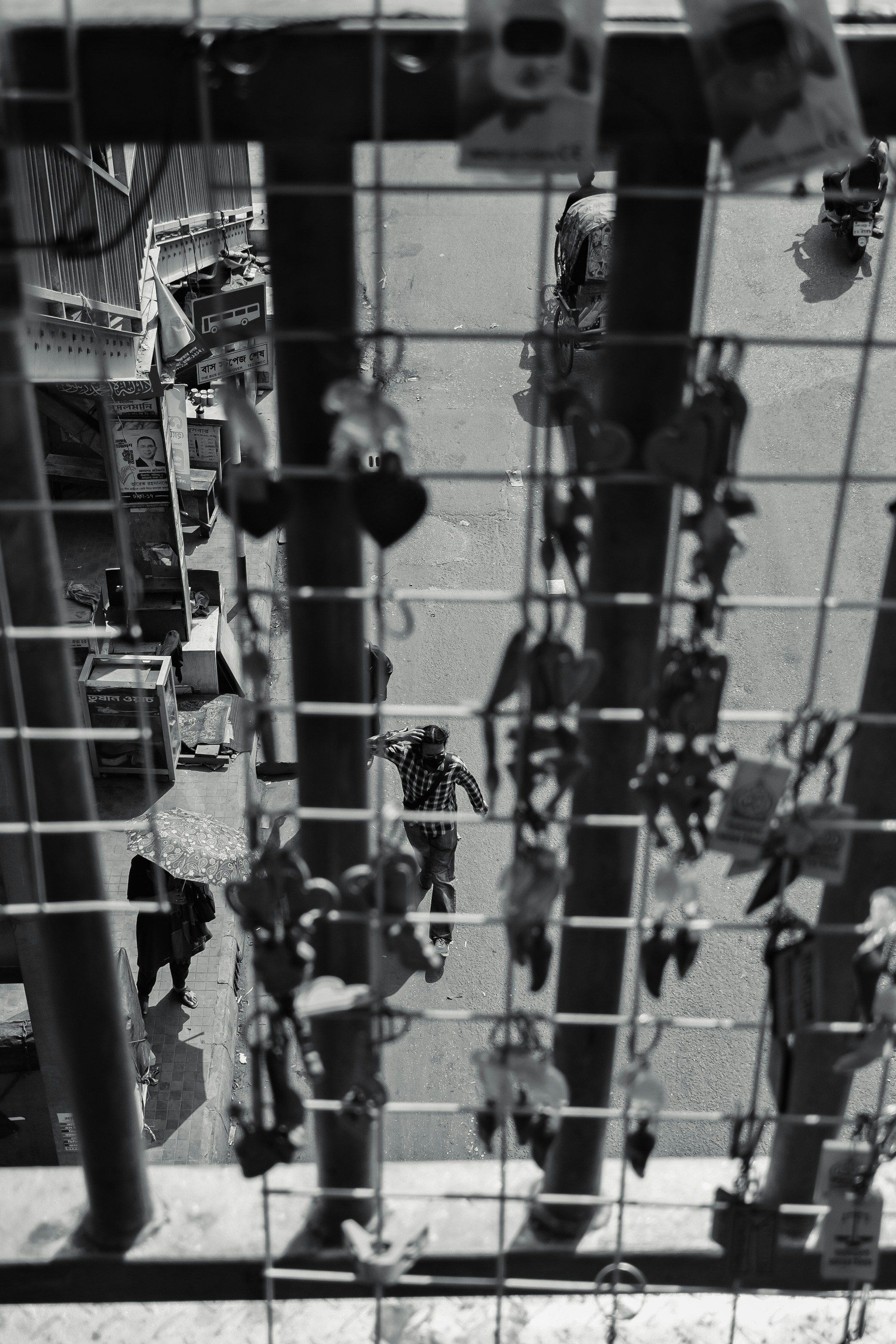 Man on the Street Beyond a Heart-Locked Fence