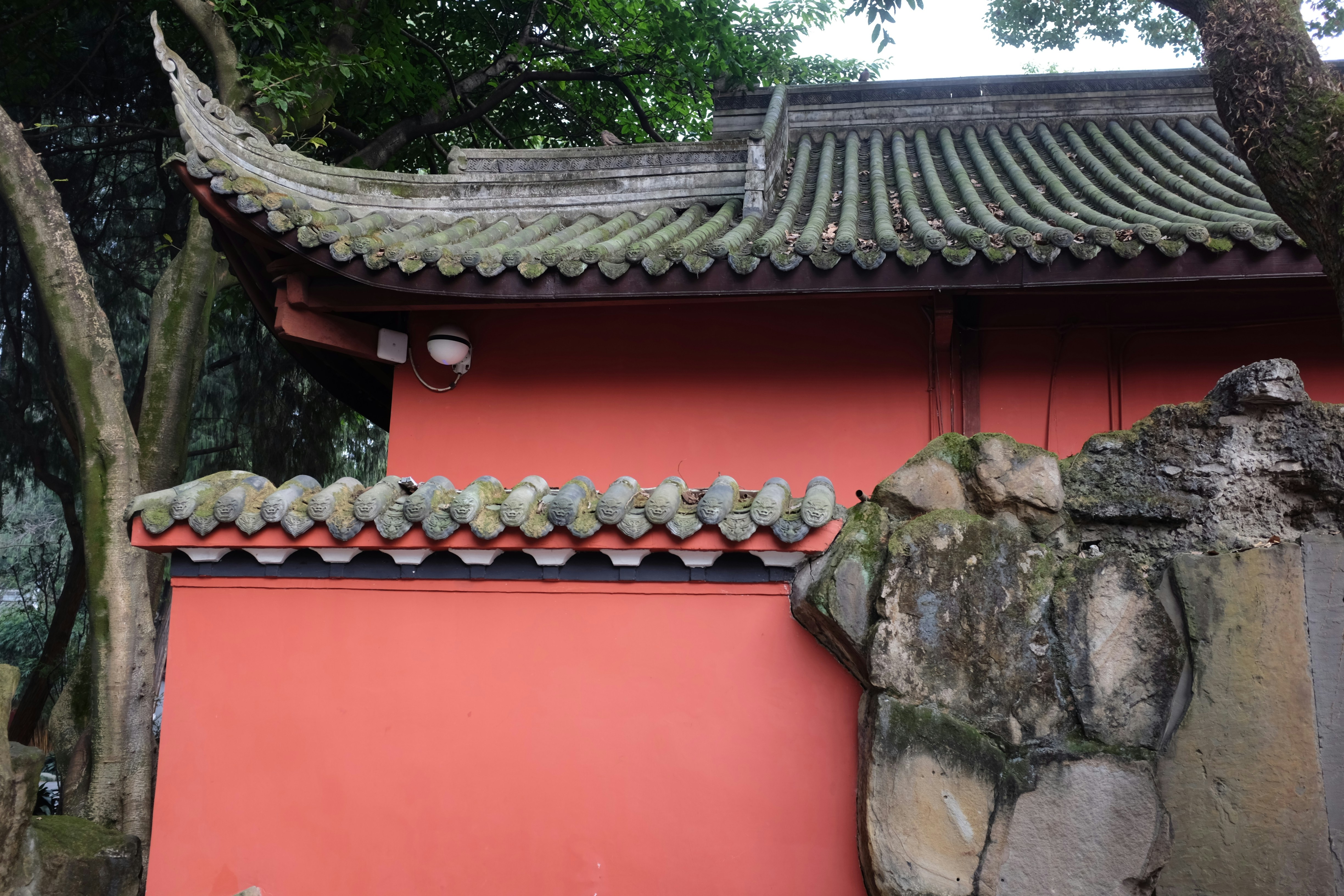 Red Wall, Quiet Rooflines: A Slice of Traditional Architecture