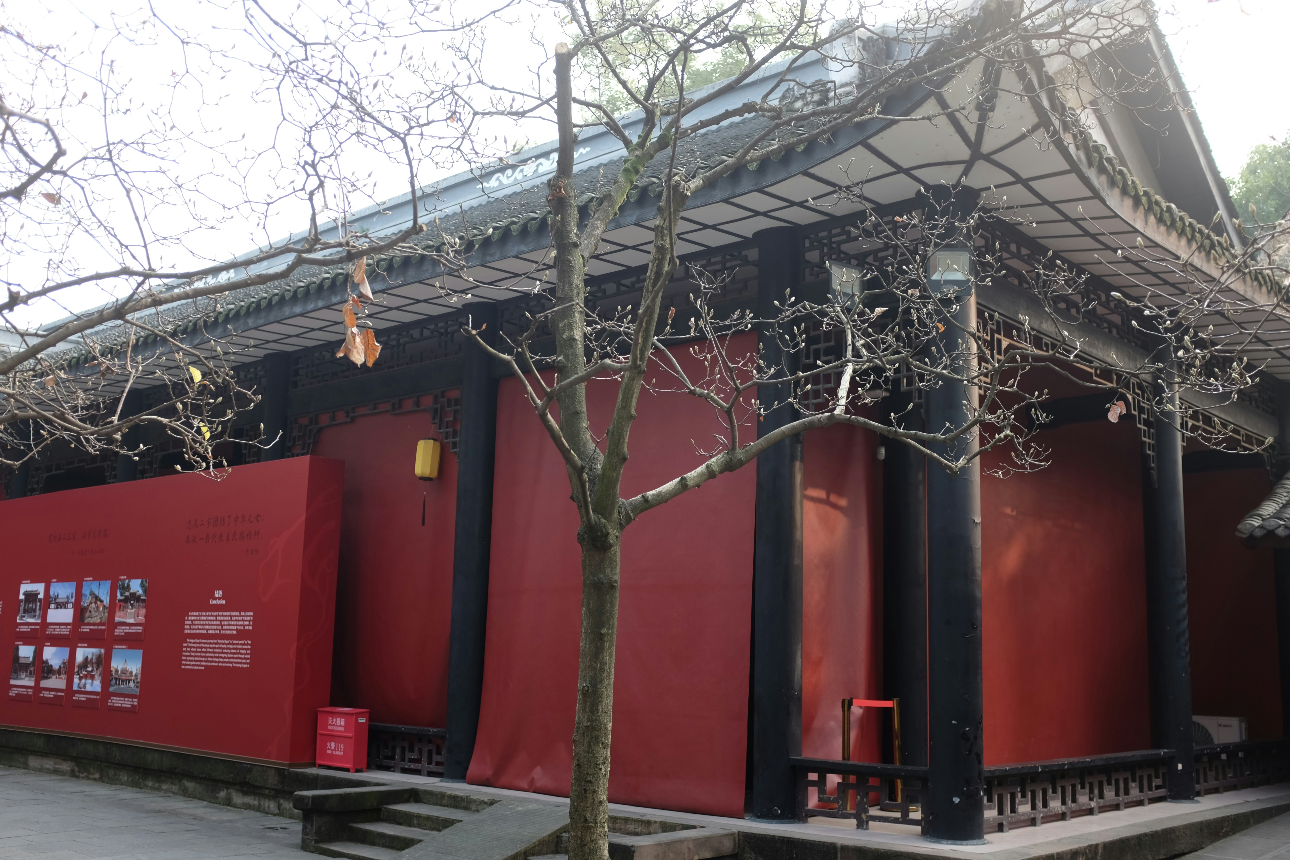 Red-walled Pavilion Framed by Bare Branches
