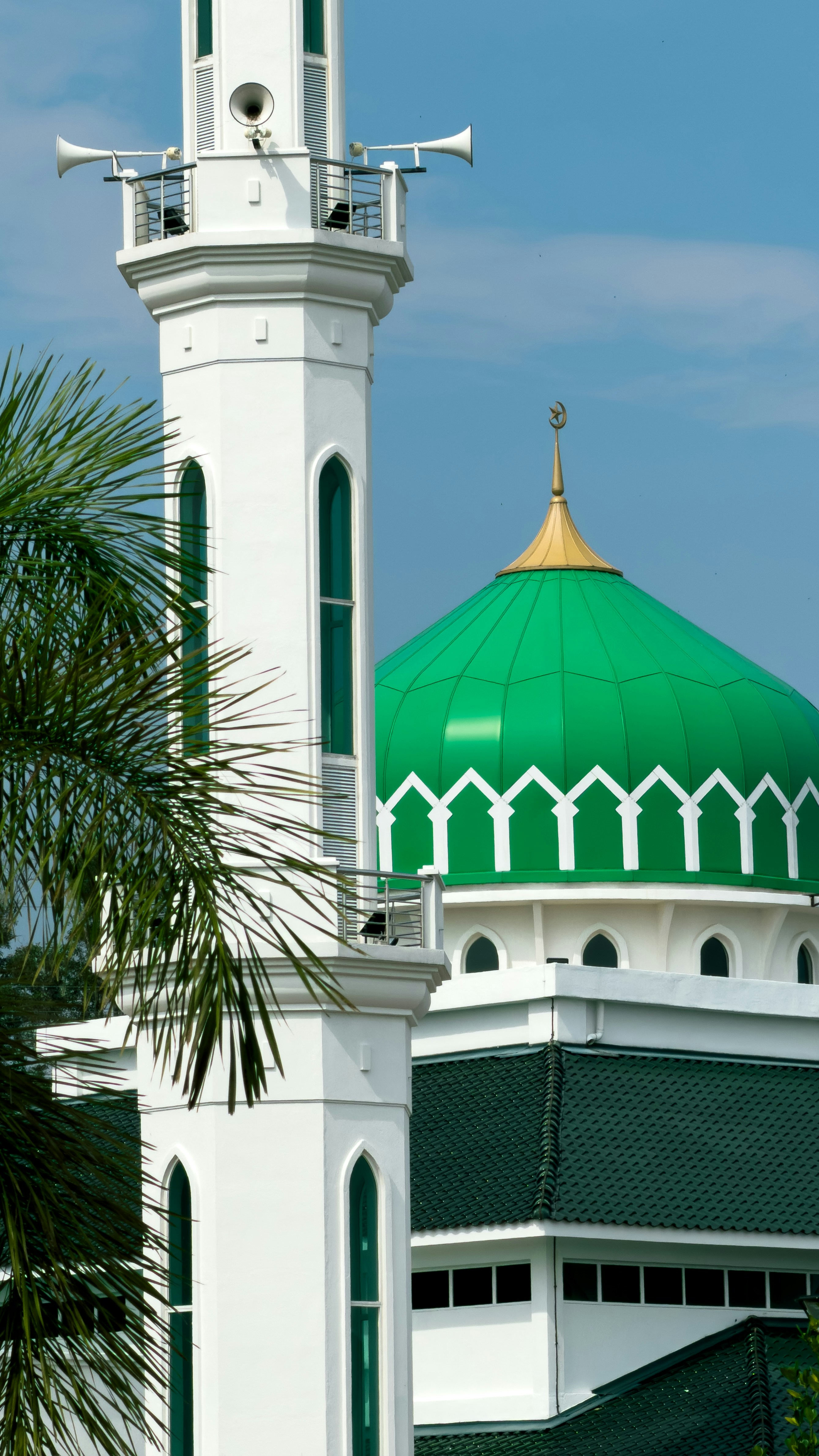 Green Dome and White Minaret Under a Blue Sky
