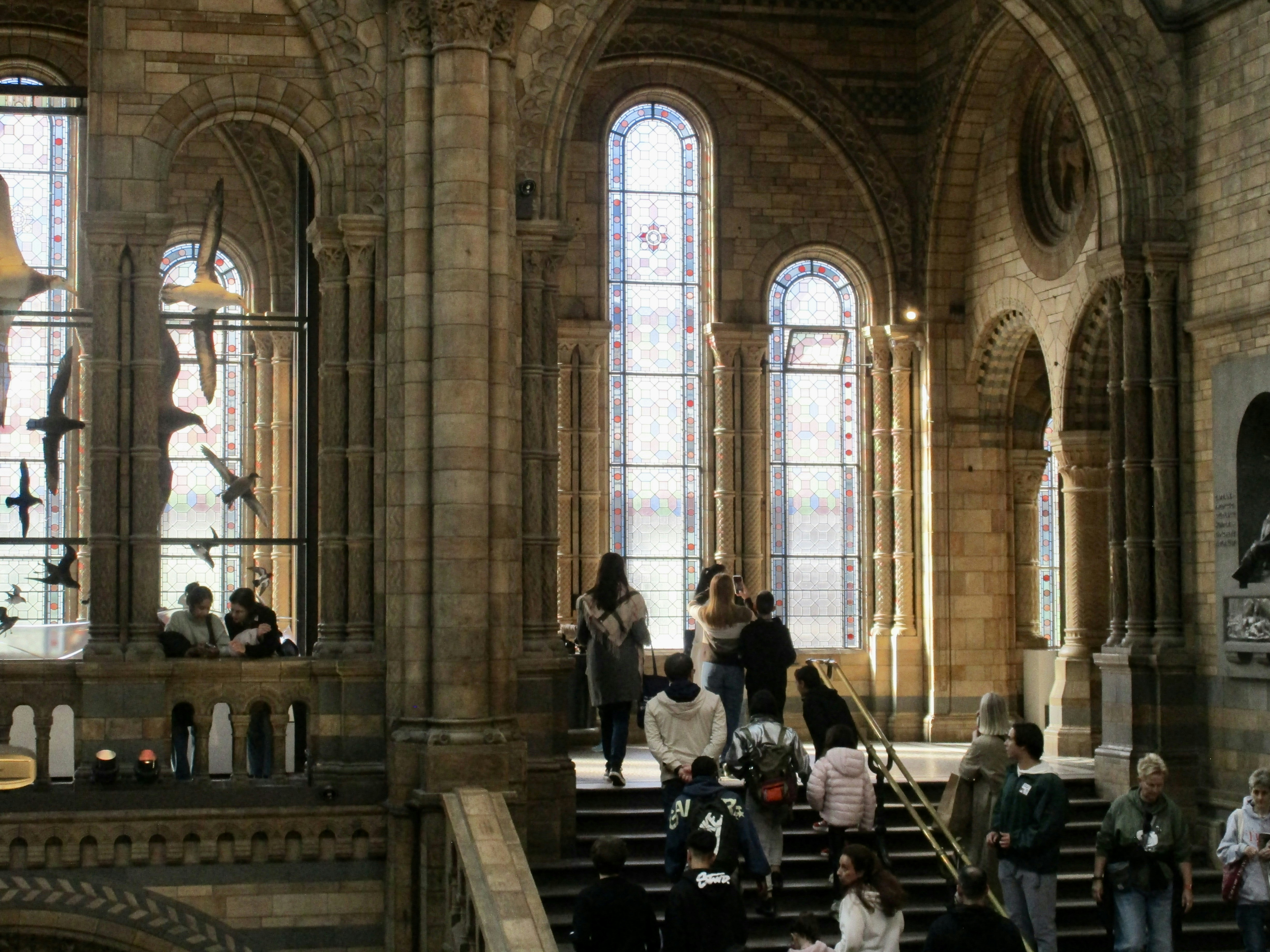 Light Through Arches: Visitors in a Historic Chapel