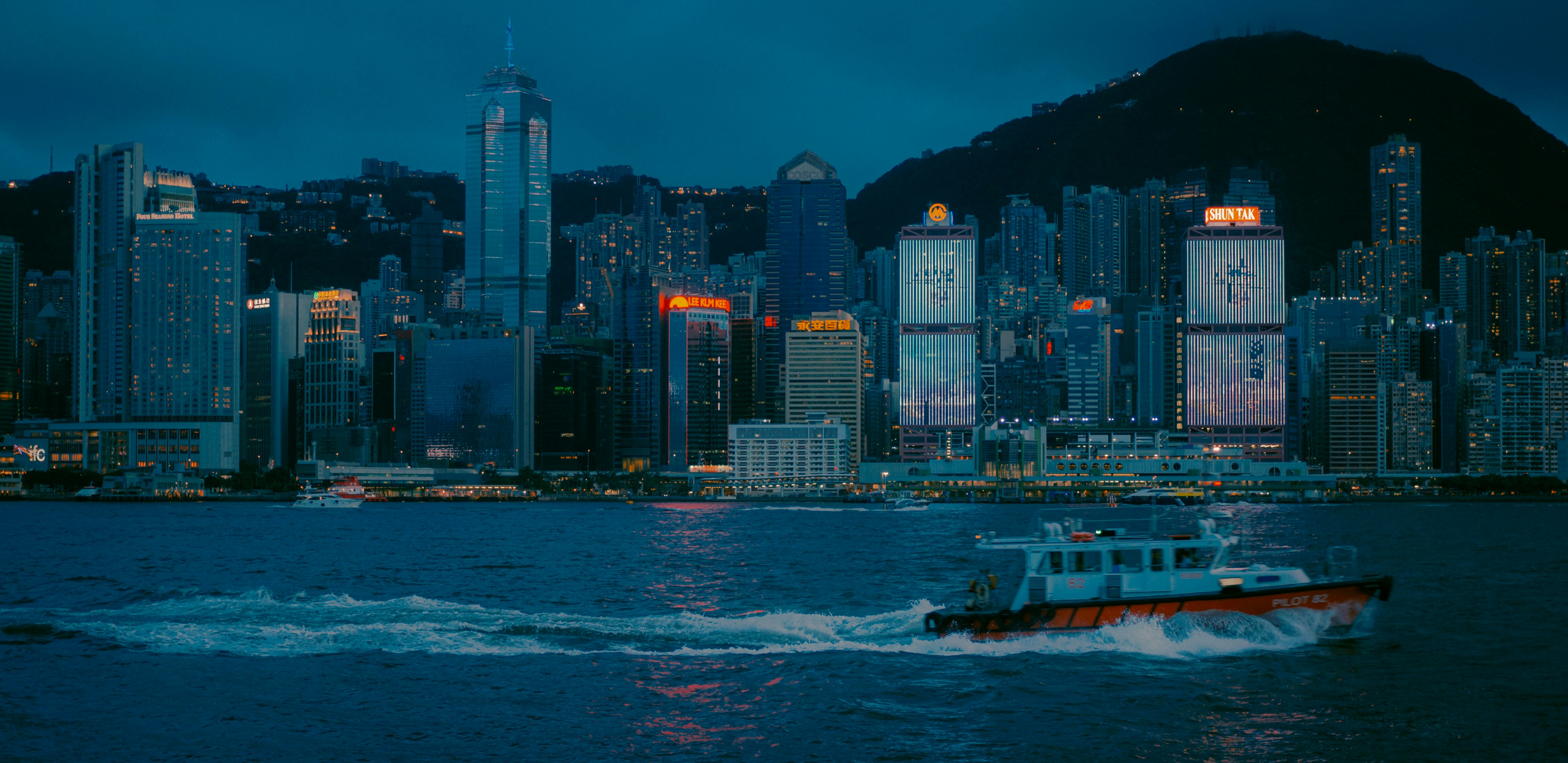 Night Ferry Across a Neon Harbor