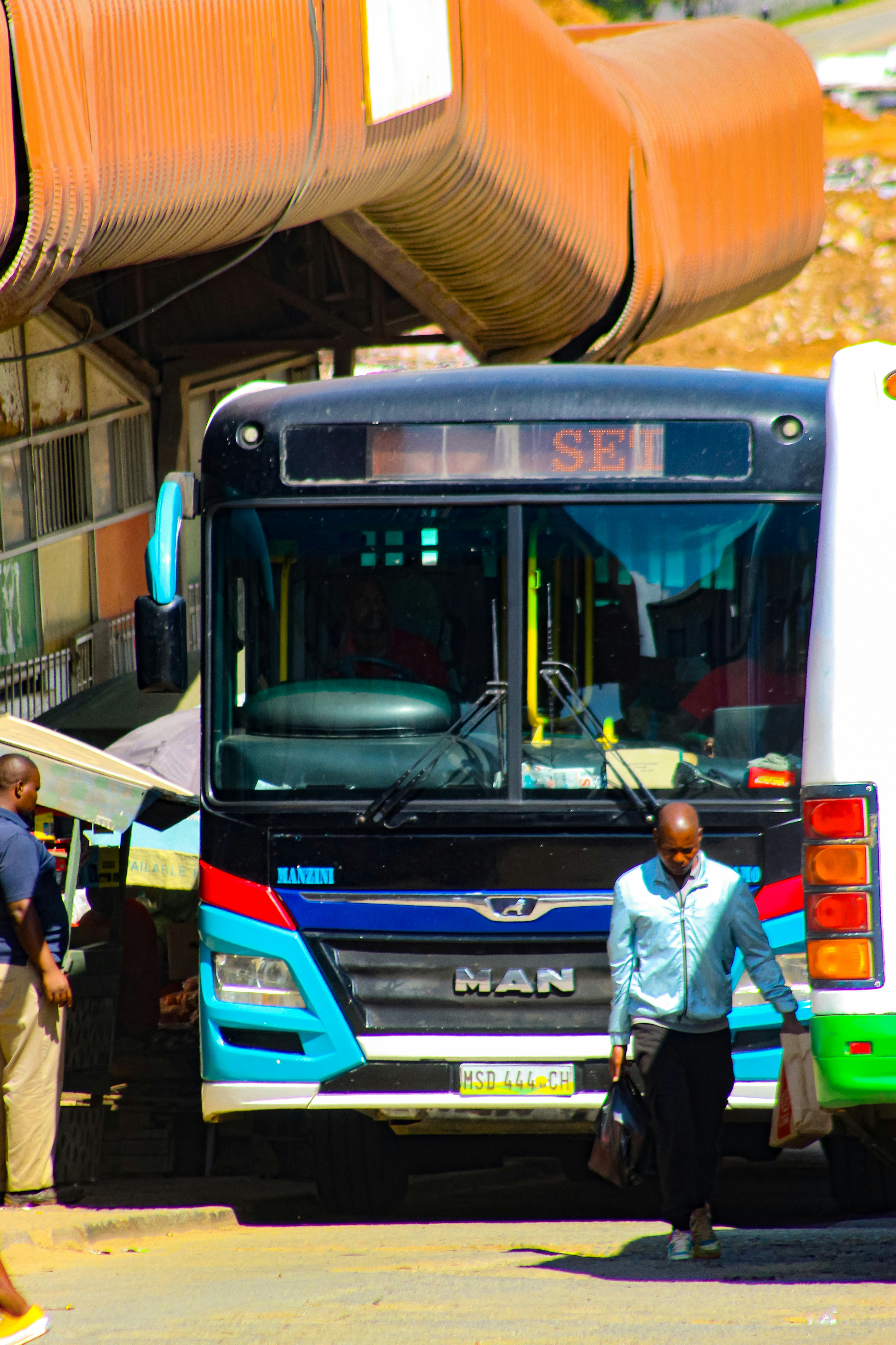 Crowded Departure: A City Bus Steers Through the Platform