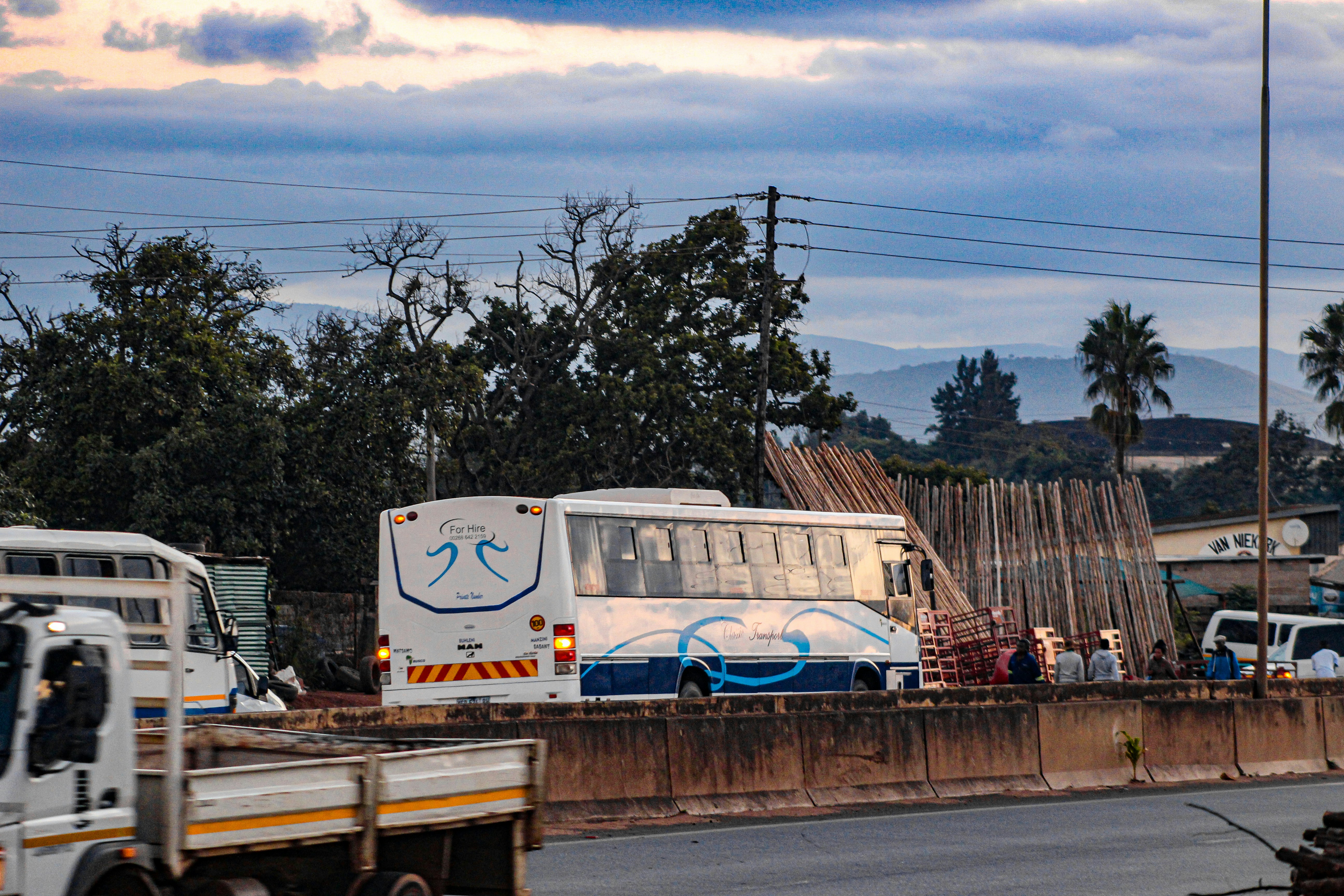 Blue-and-White Bus Pause on a Rural Route