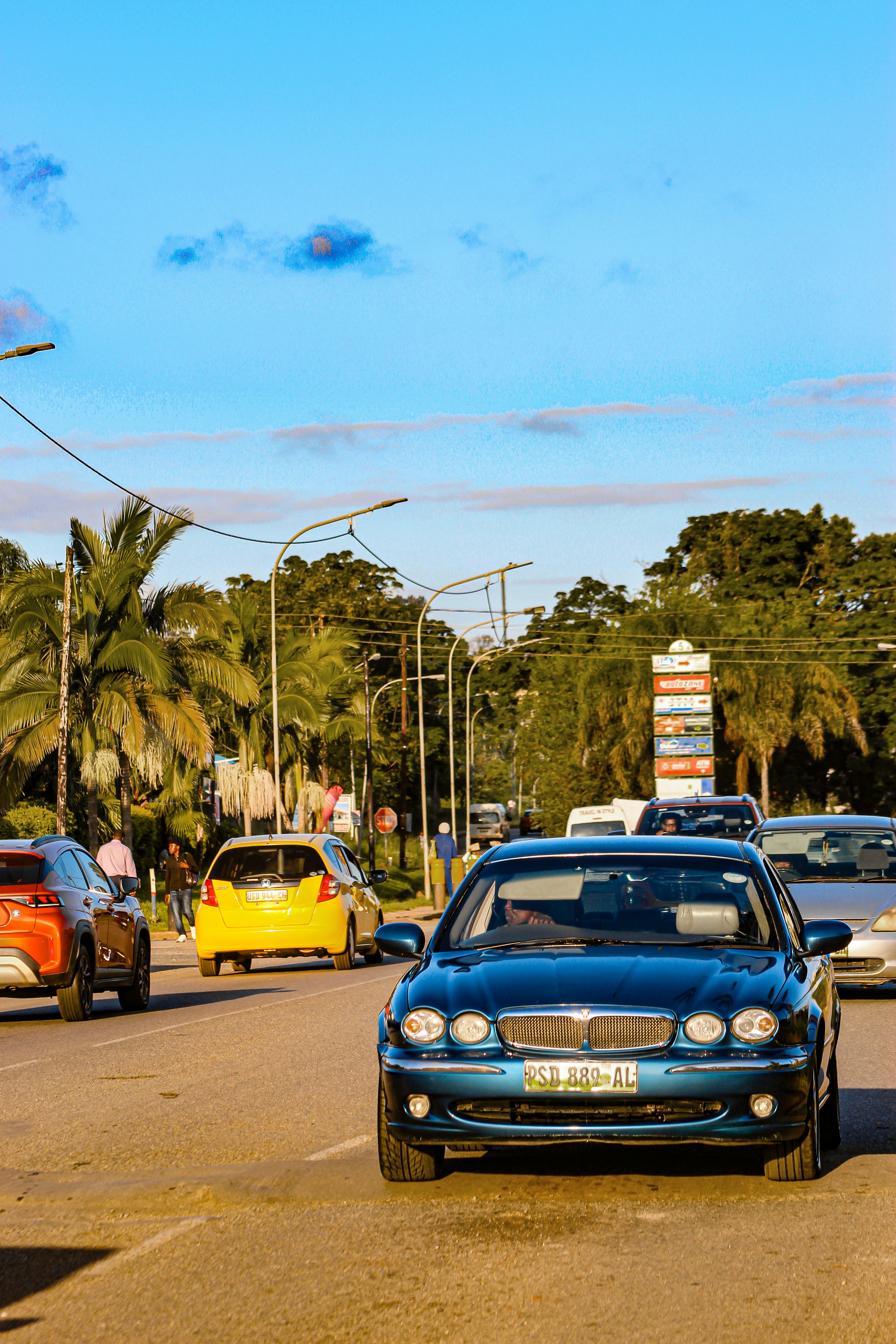 Blue Jaguar on a Sunlit Avenue