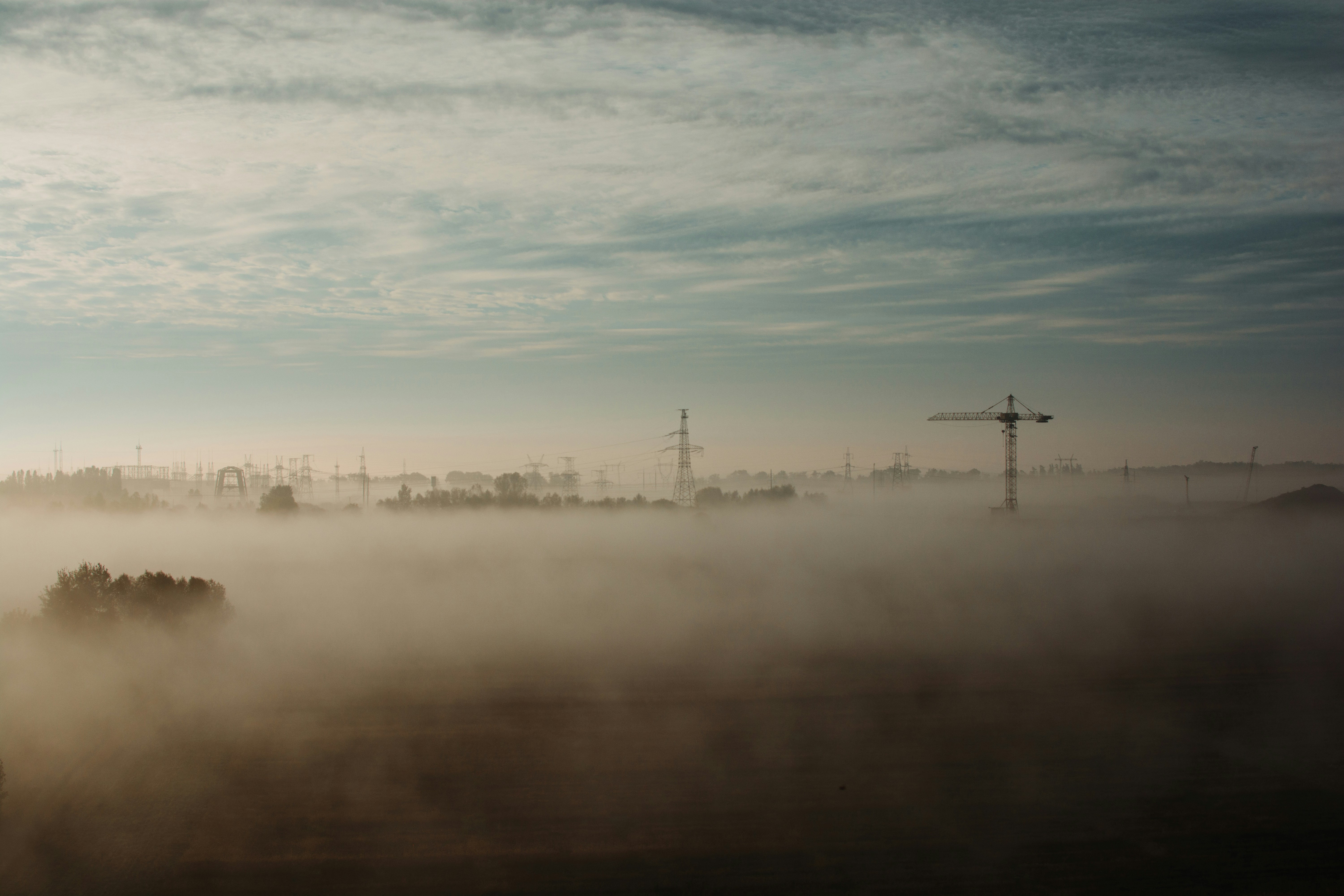 Mist over the Grid: Dawn Fog Beneath Transmission Towers