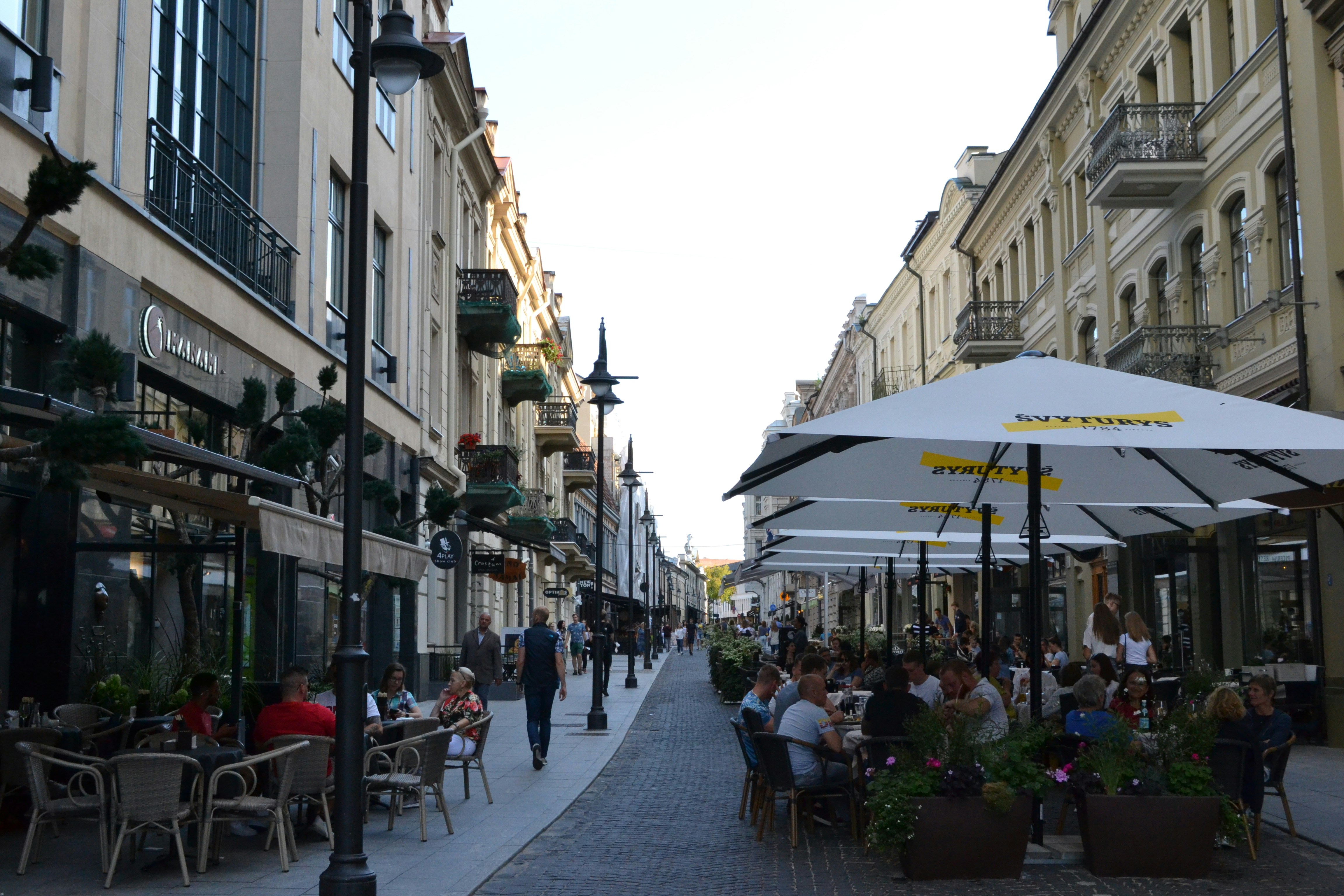 Sunlit Arcades and Café Ambience Along a European Pedestrian Street