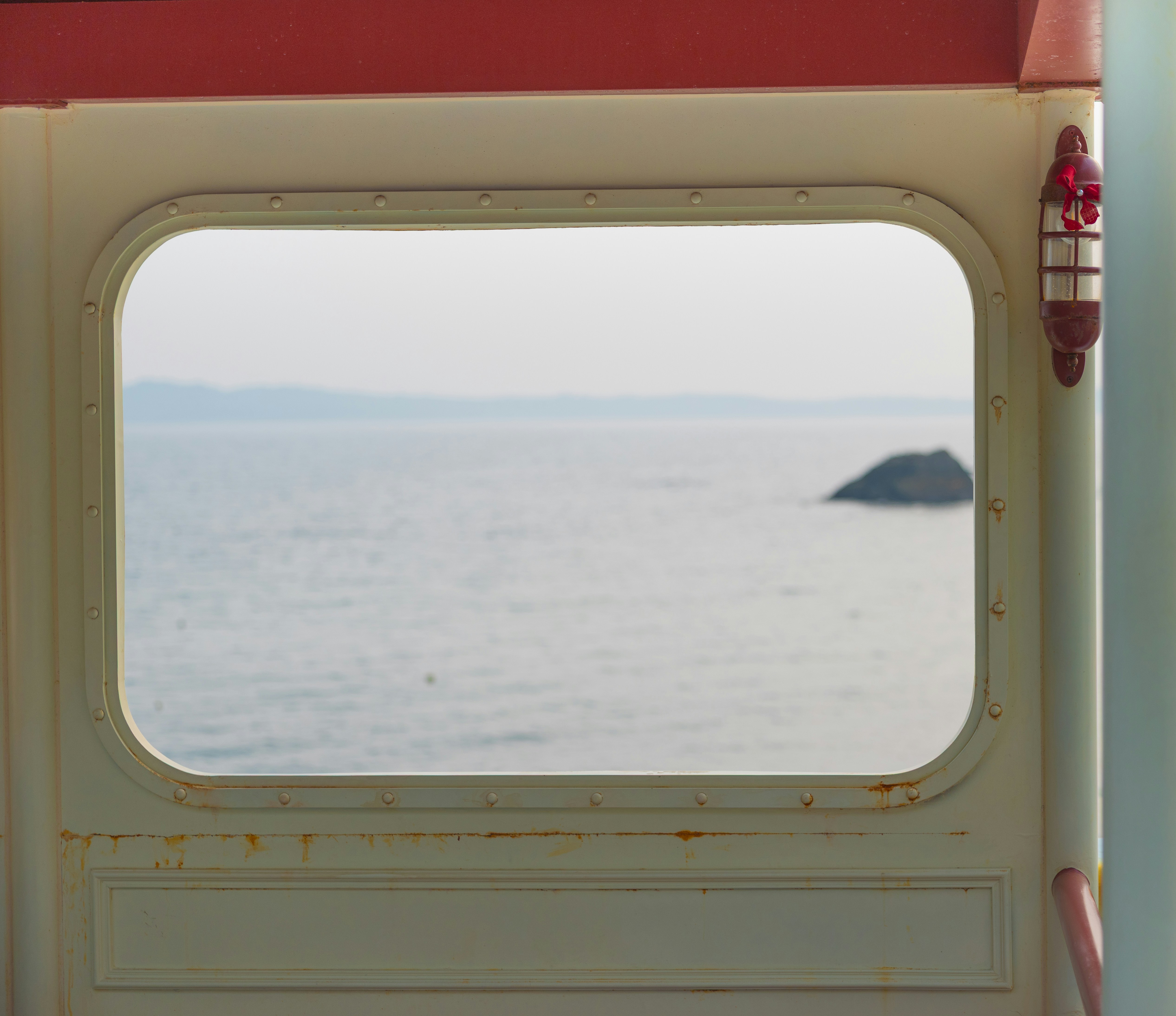 Horizon Framed by a Porthole Window