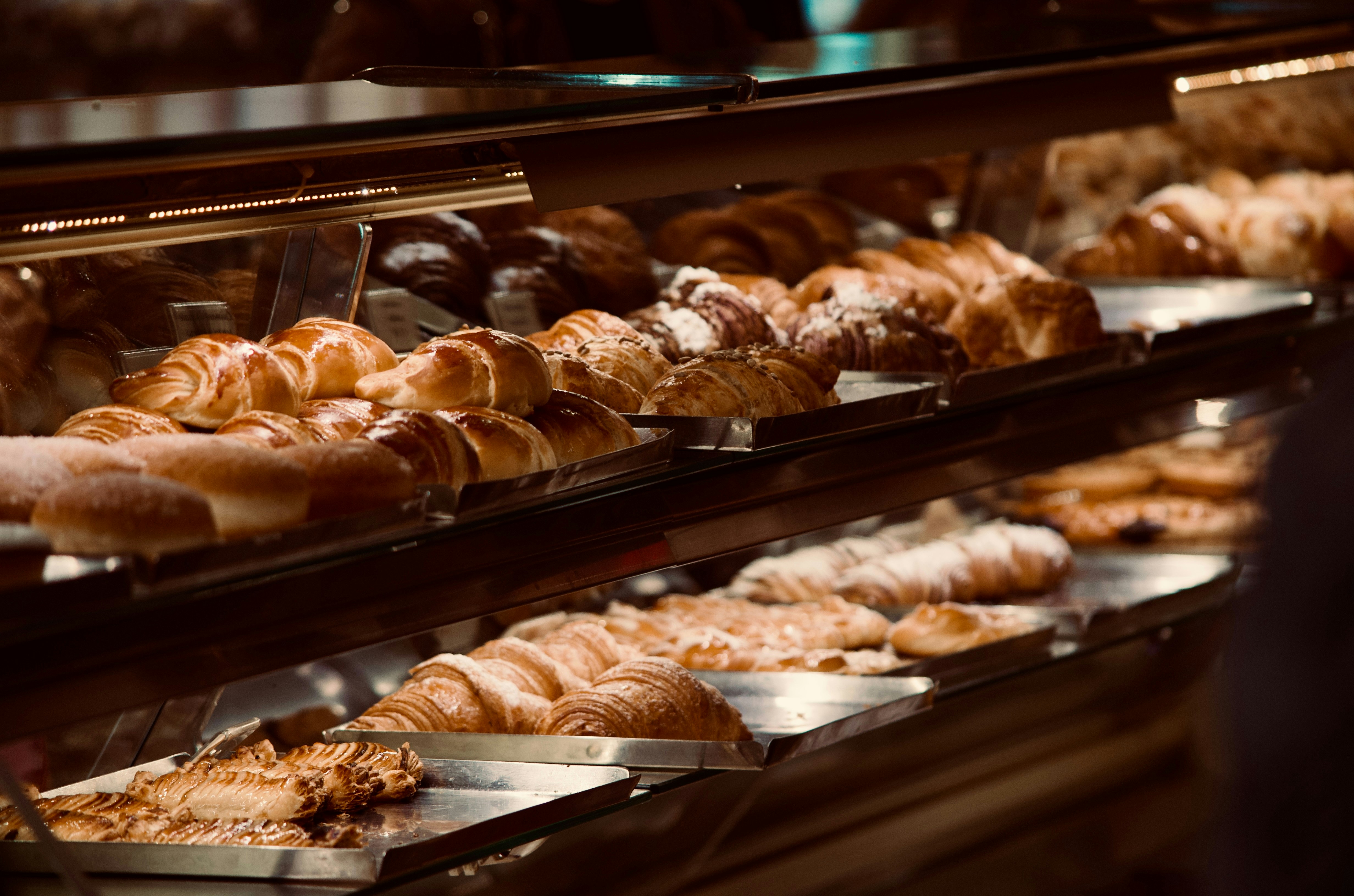 Rows of Warm Pastries: Amber Light in a Bakery Display