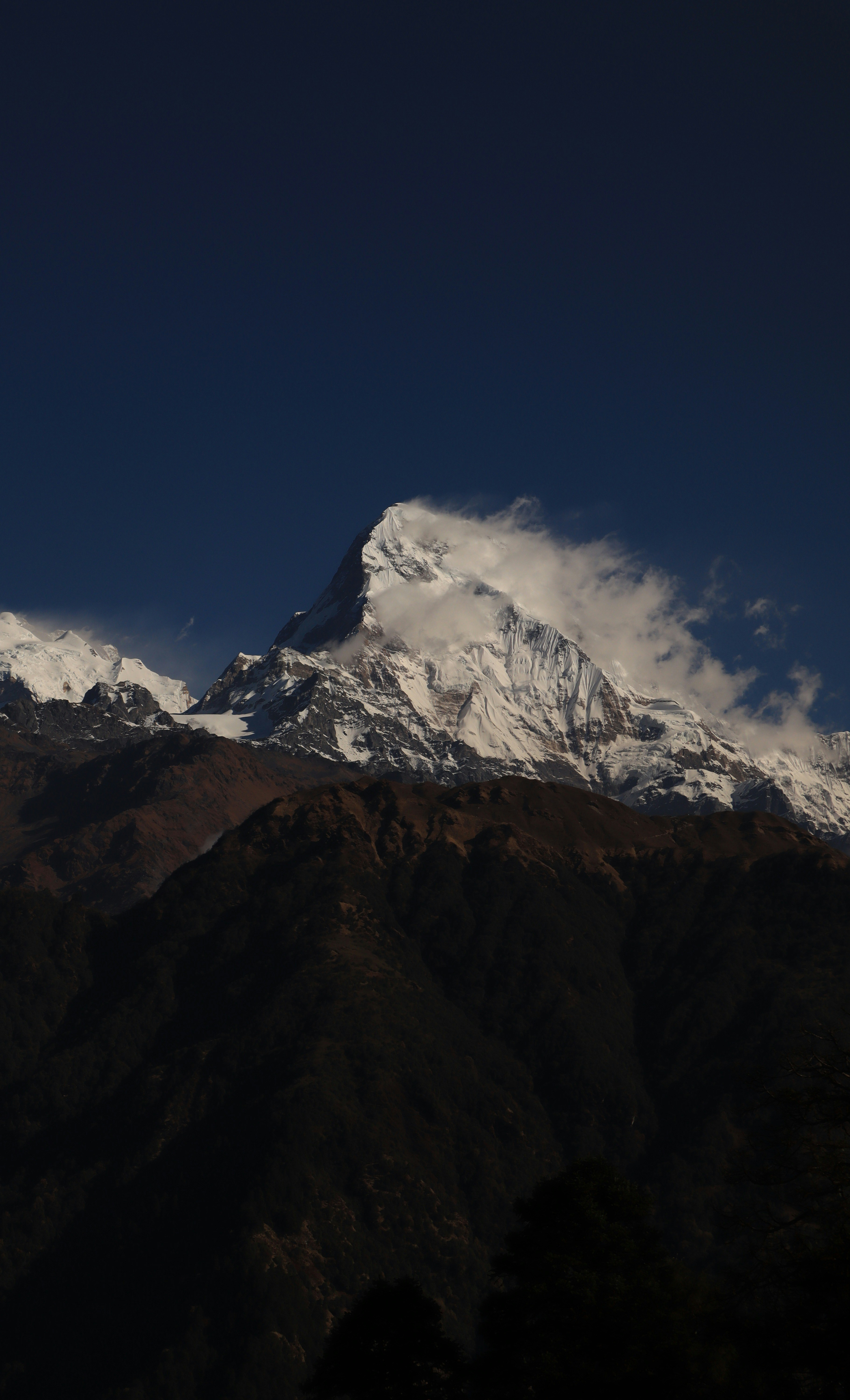 Snowbound Summit Under a Veiled Blue Sky