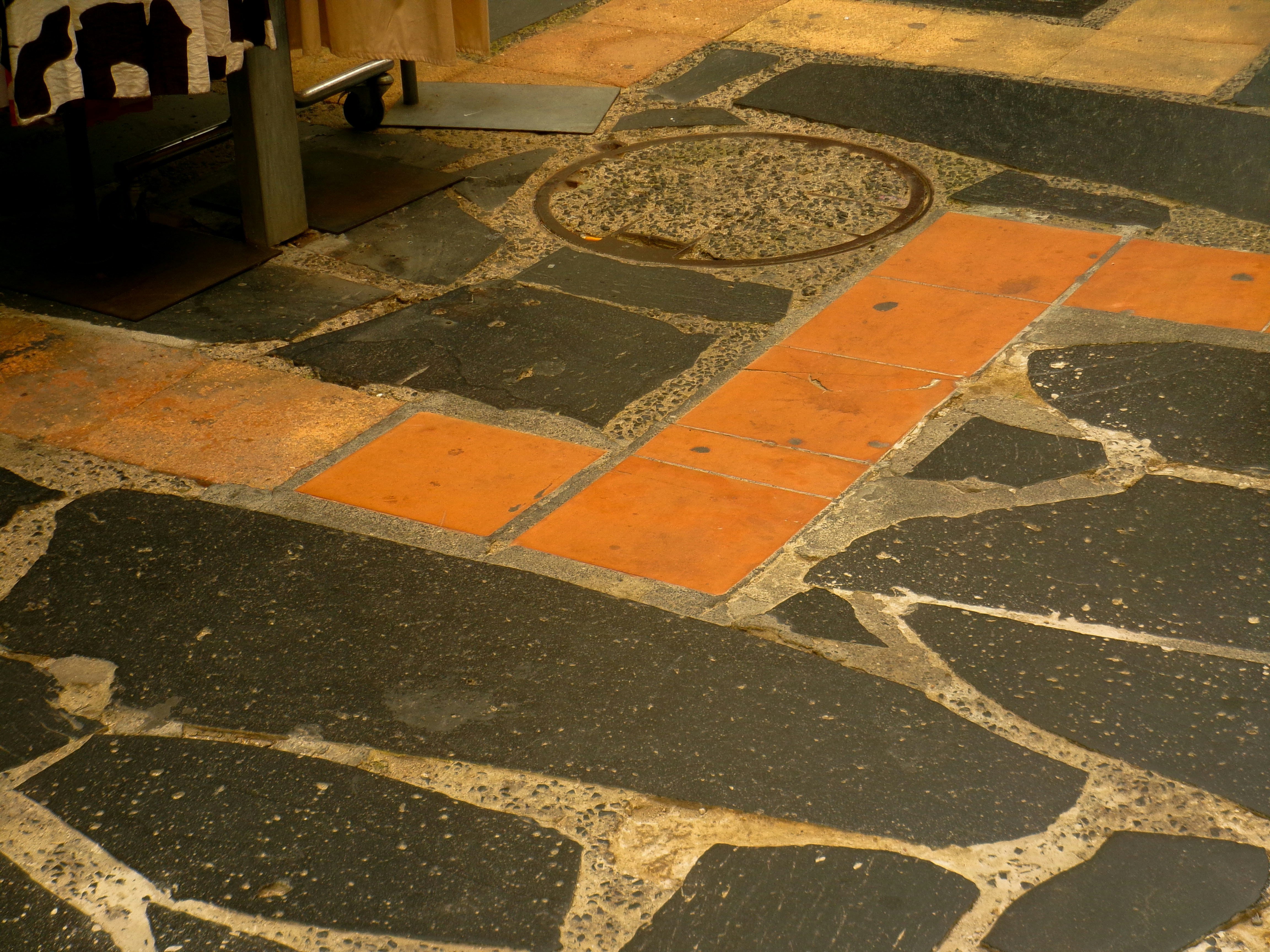 Urban Mosaic: Orange Tiles Framing a Quiet Sidewalk