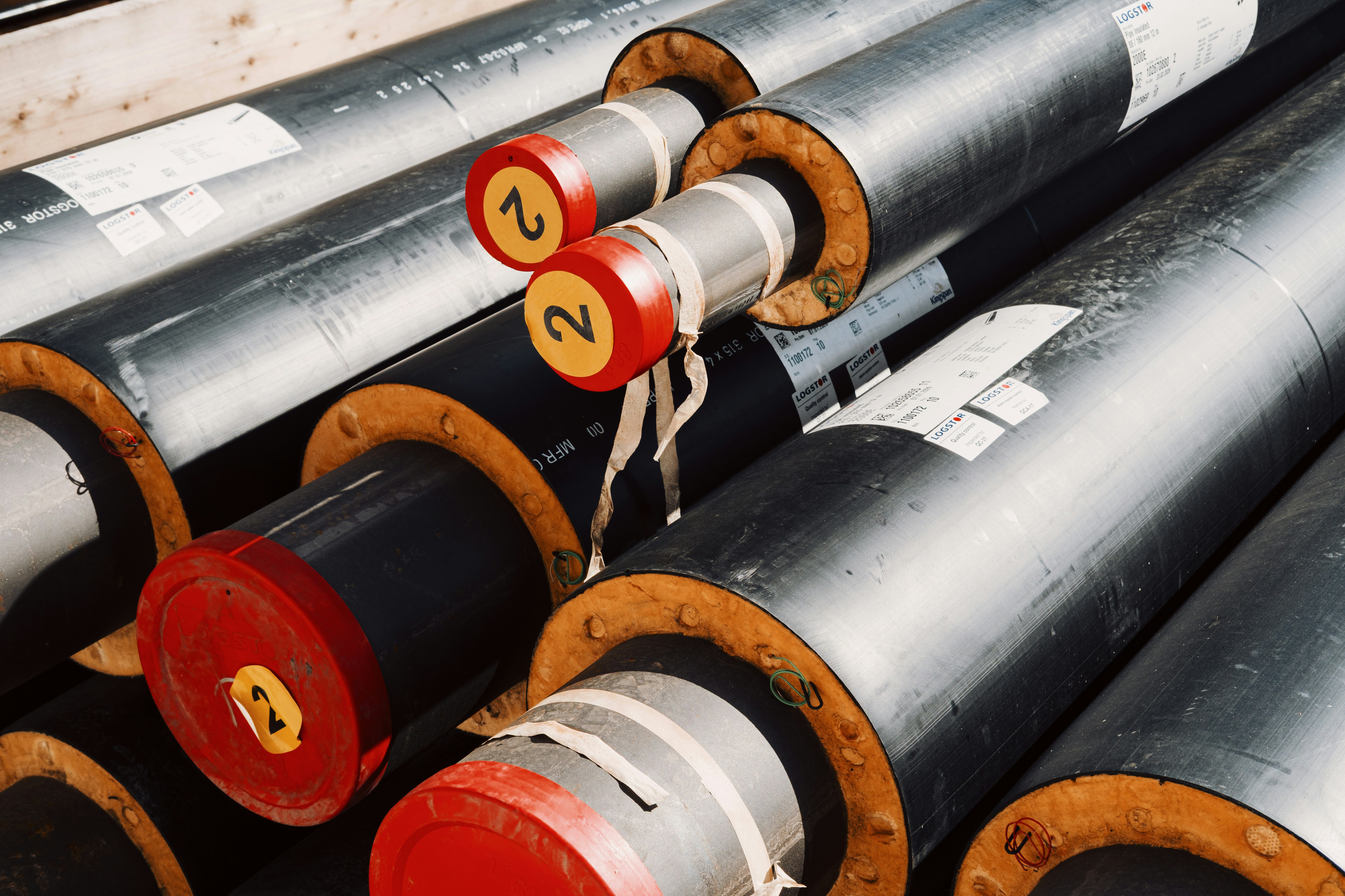 Casked Cylinders: Red-Capped End Caps among Industrial Pipes