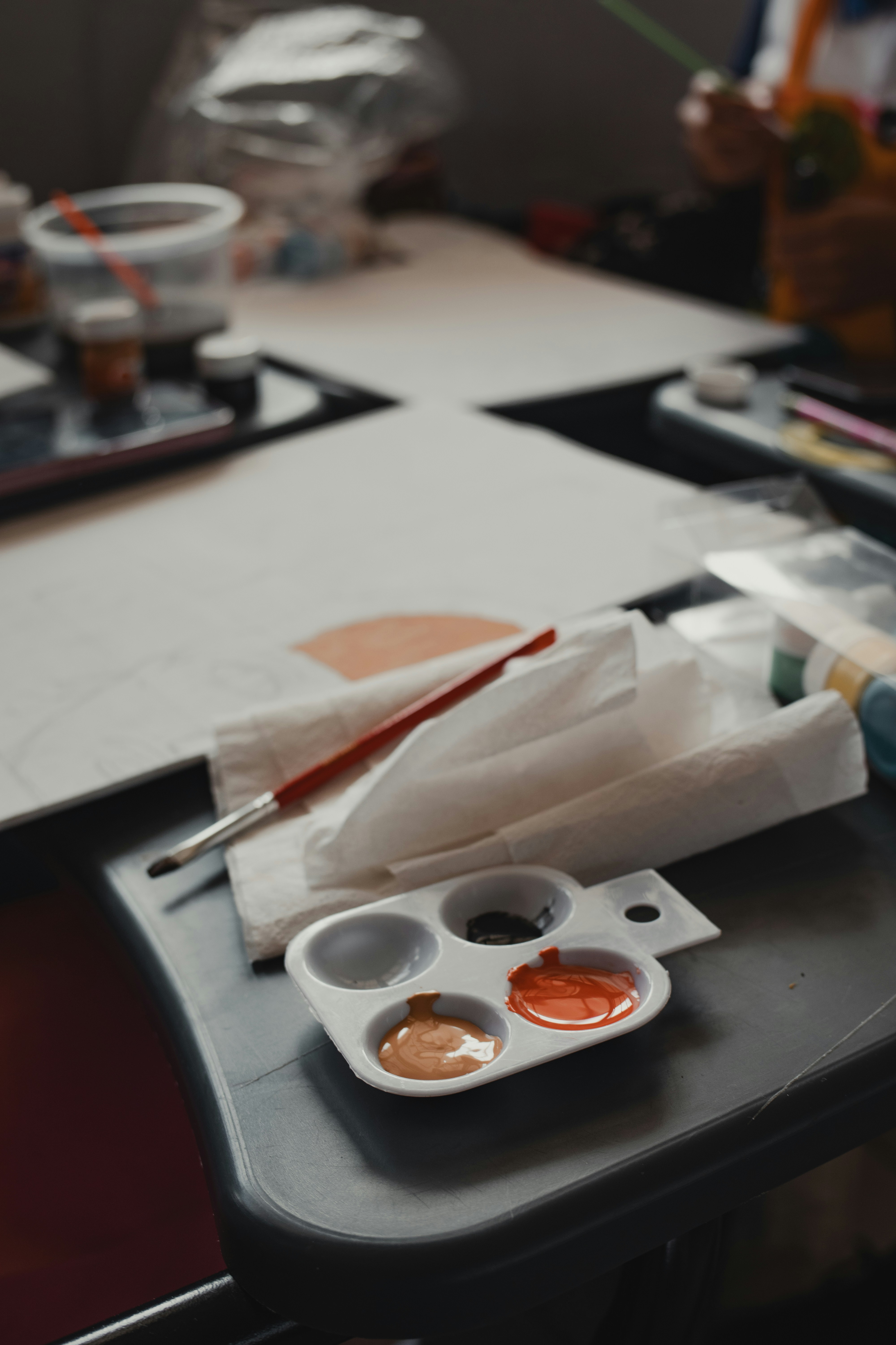 Palette at the Table: A Close-Up of Crafting Tools and Paints