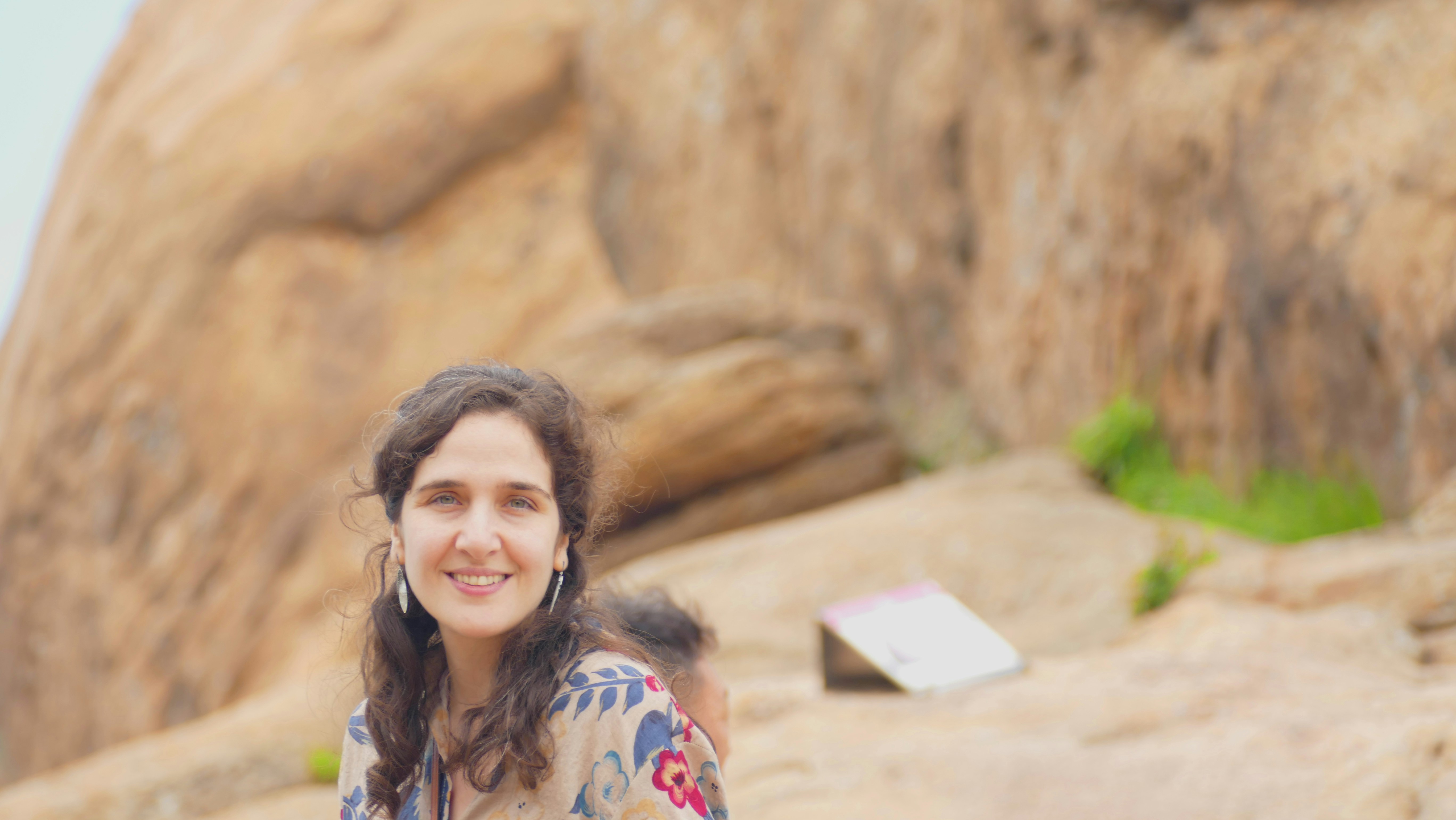 Portrait on the Tidal Rock: A Smiling Wanderer against a Desert Cliff