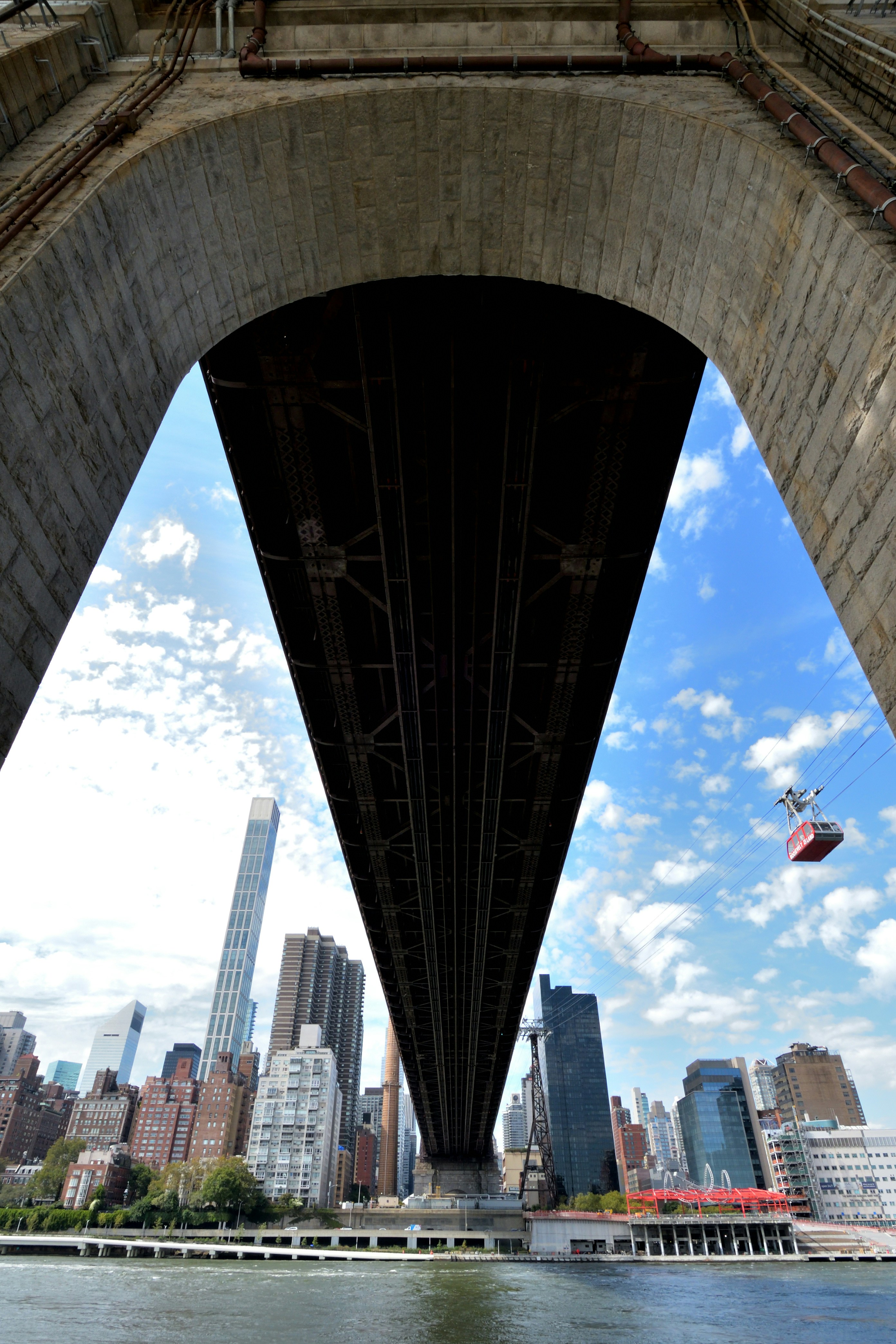 Under the Iron Veil: Cityscape Framed by a Mighty Bridge
