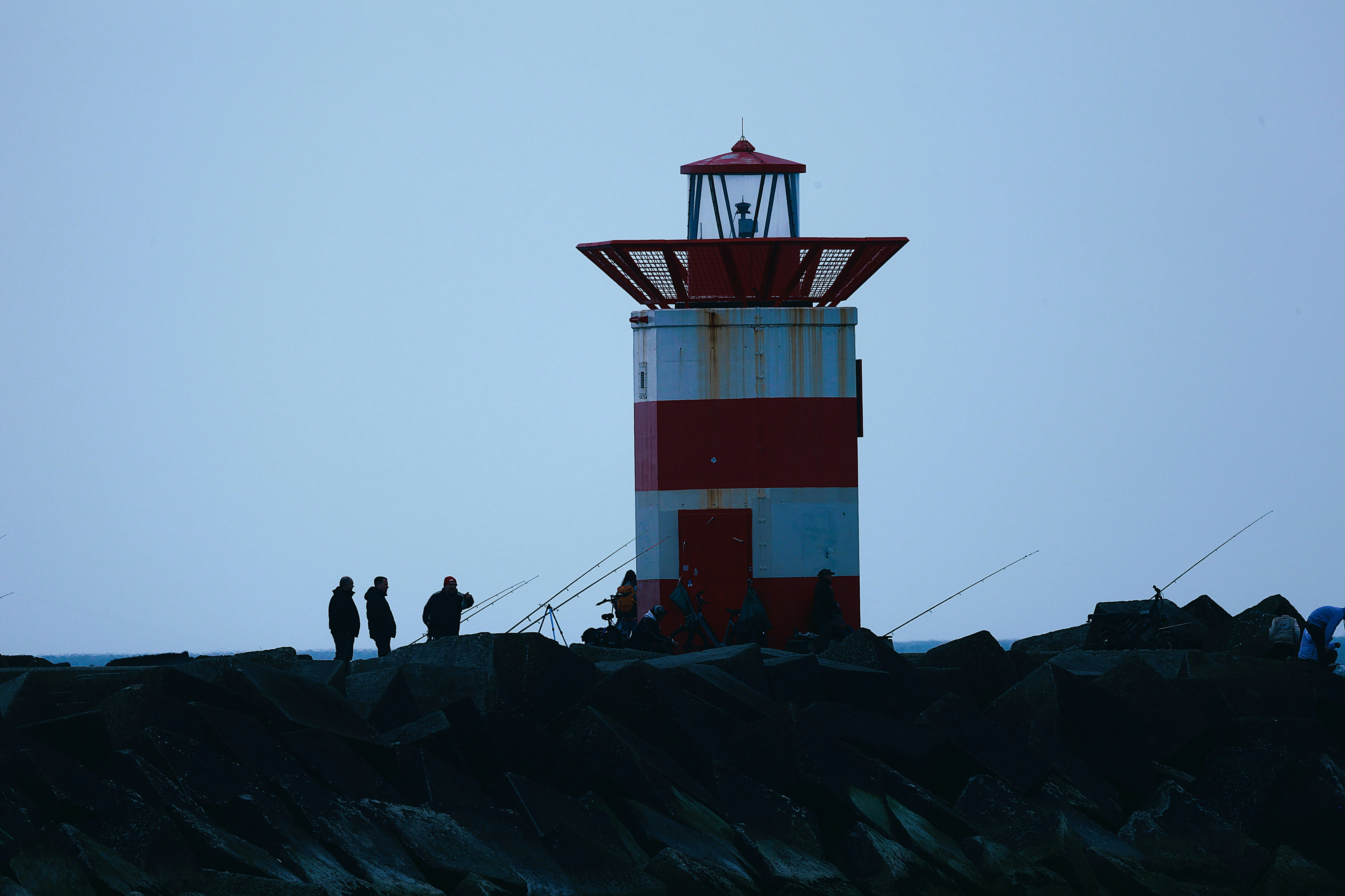 Coastal Watch: The Striped Beacon Standing Against Dusk