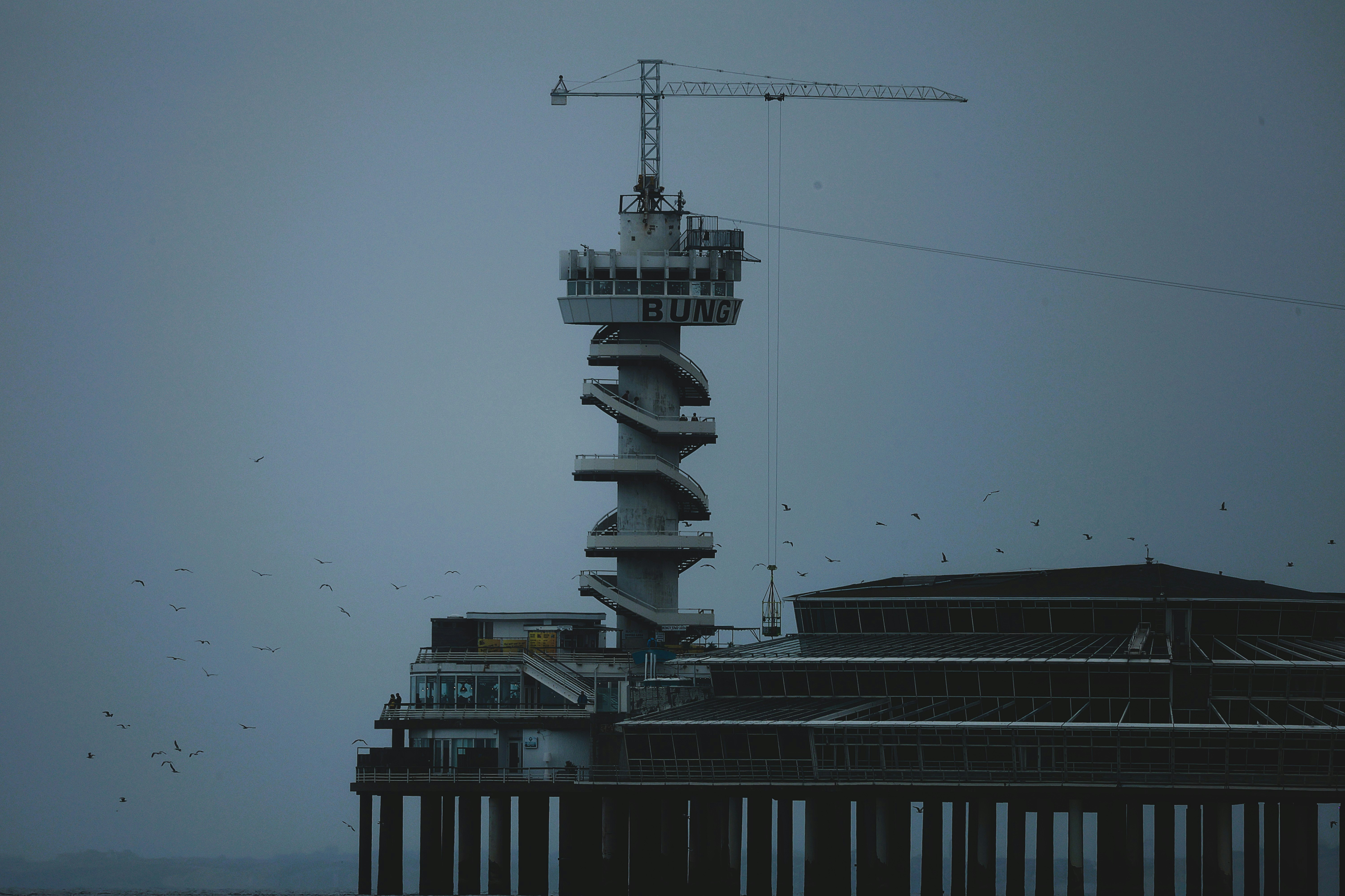 Crane Lanterns over a Weathered Pier