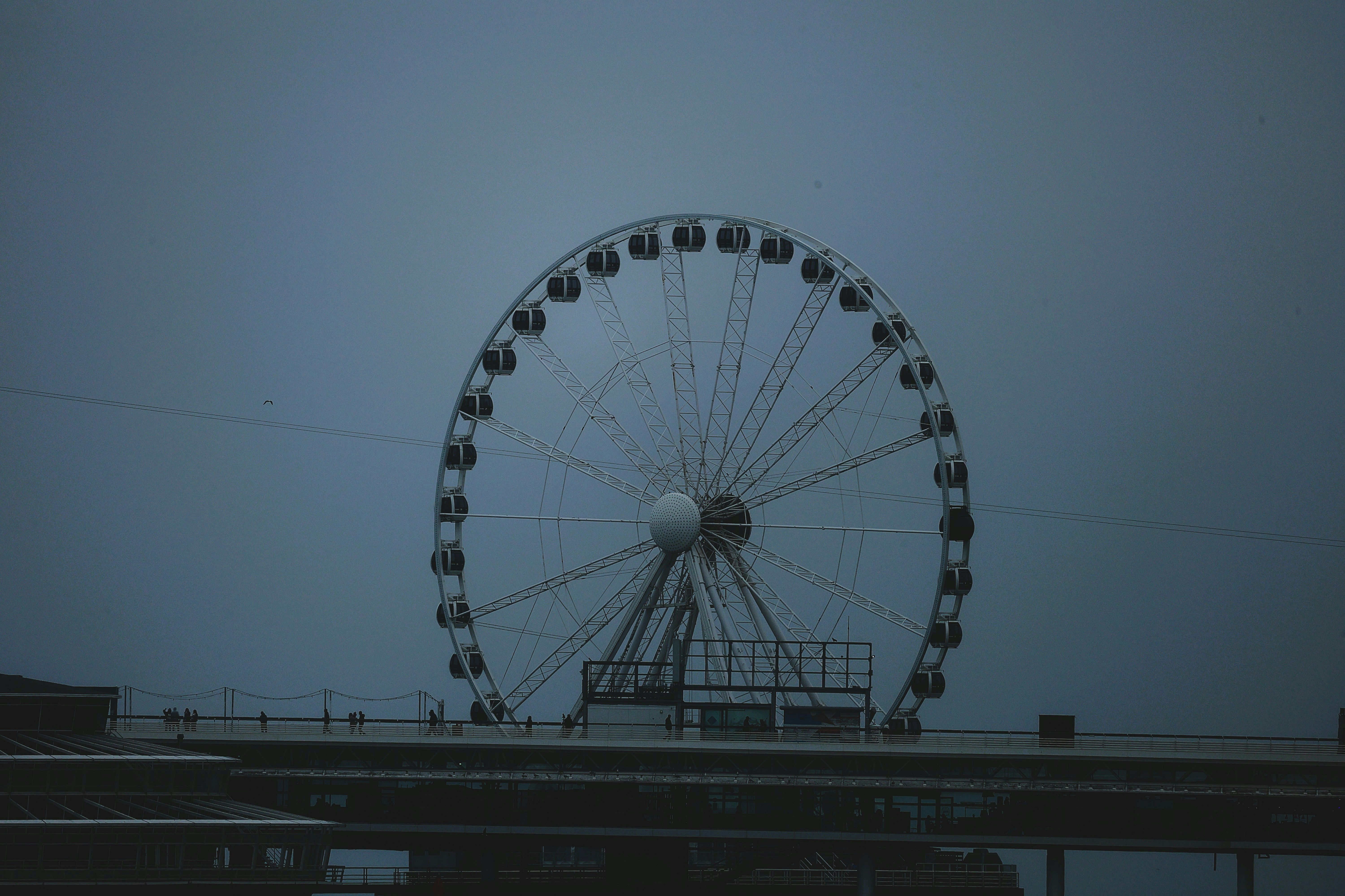 Midnight Wheel: A Quiet Skyline with a Distant Ferris Circle