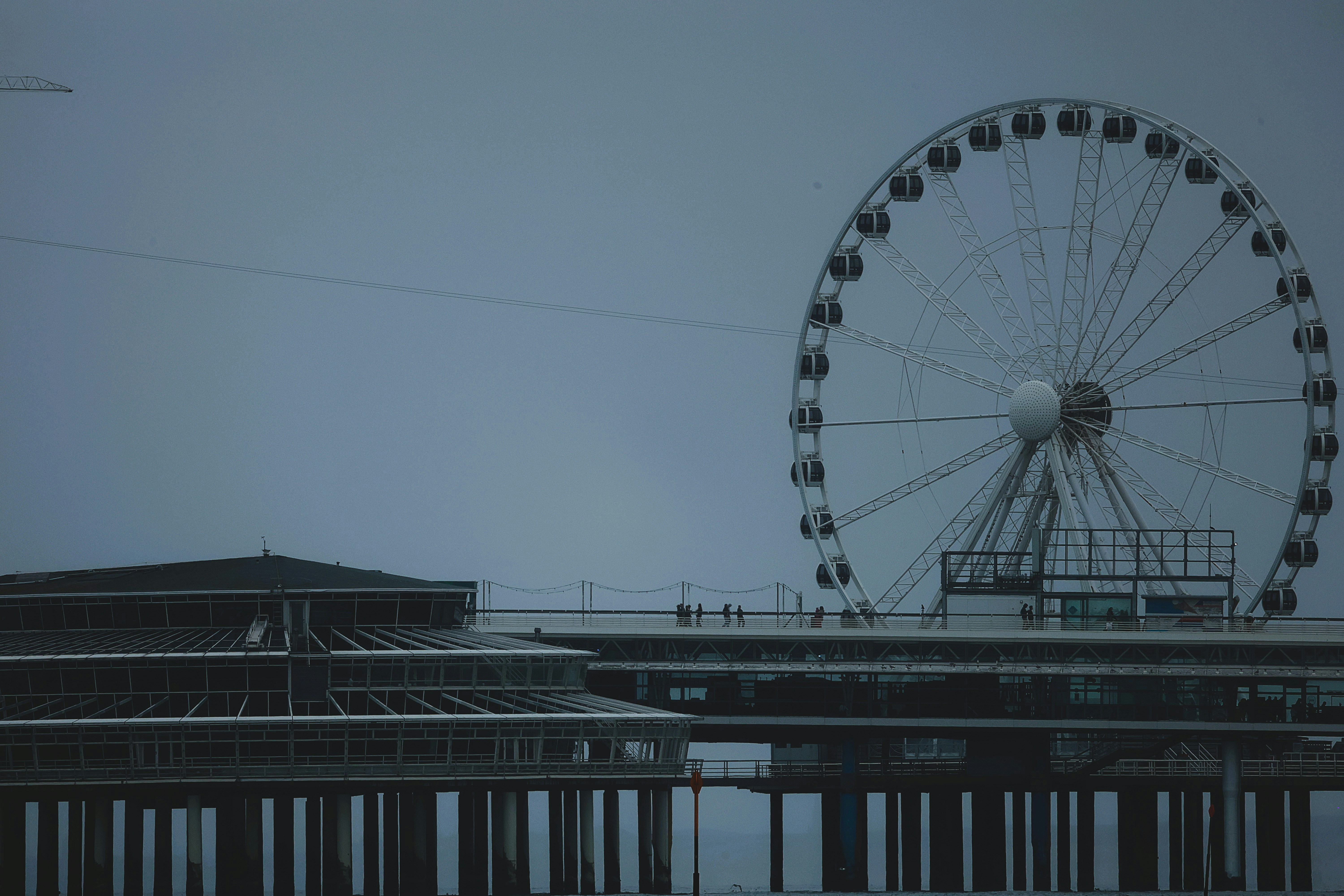 Ferris Wheel Over Pier: Quiet Oceanic Skyline