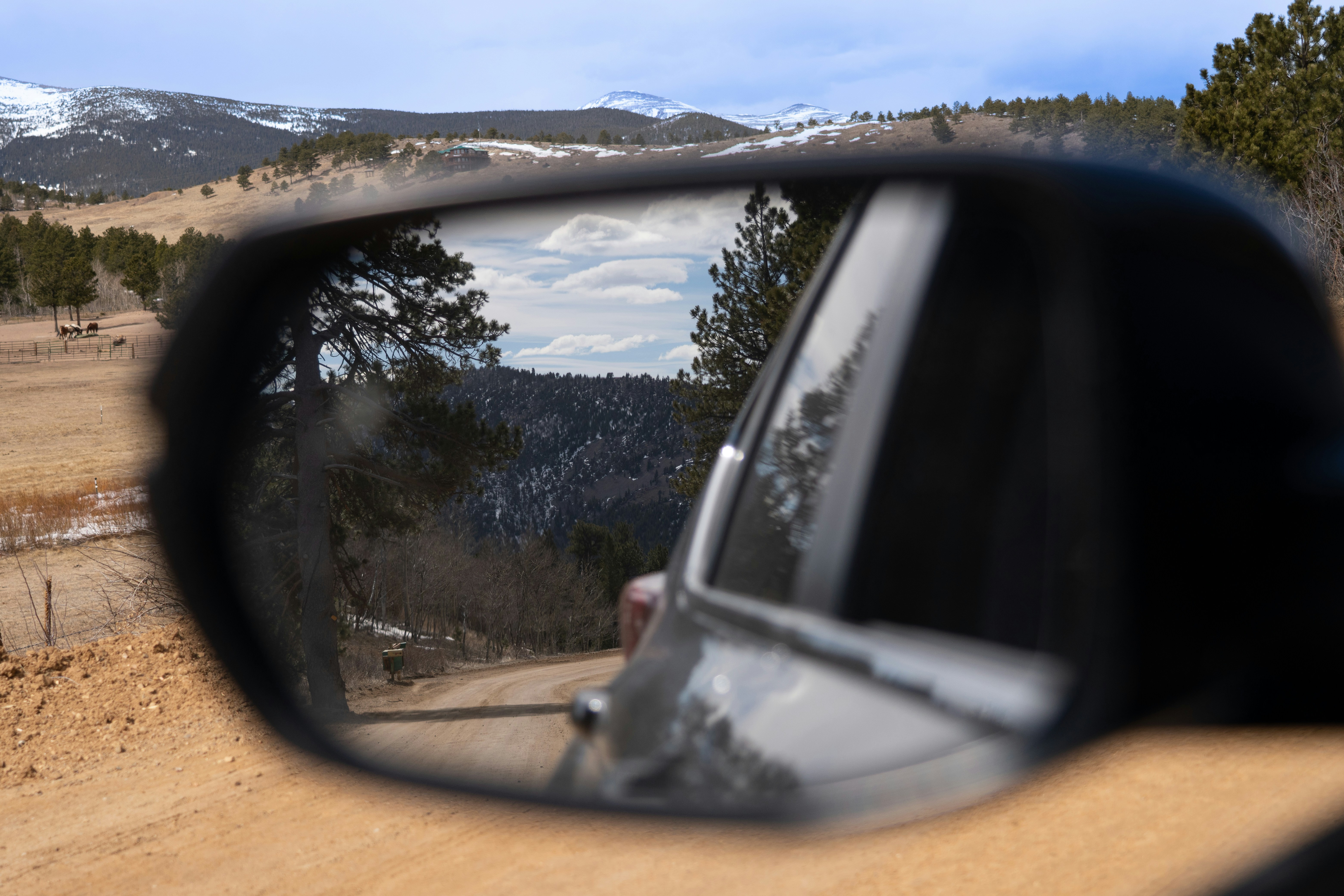 Through a Rear-View Window: Mountain Landscape Framed in a Car Mirror